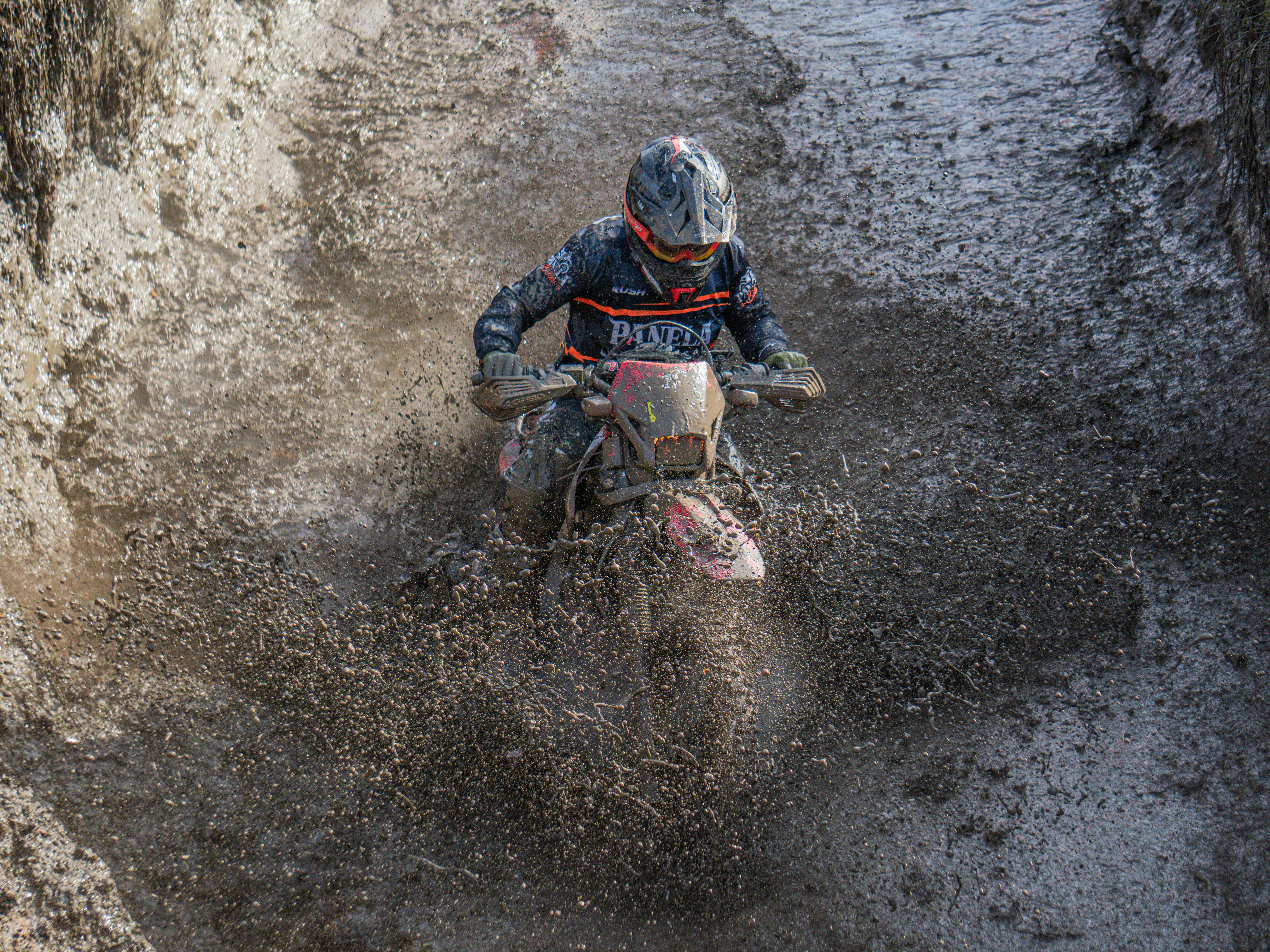 Thrilling Motorcycle Adventure in Muddy Terrain · Free Stock Photo