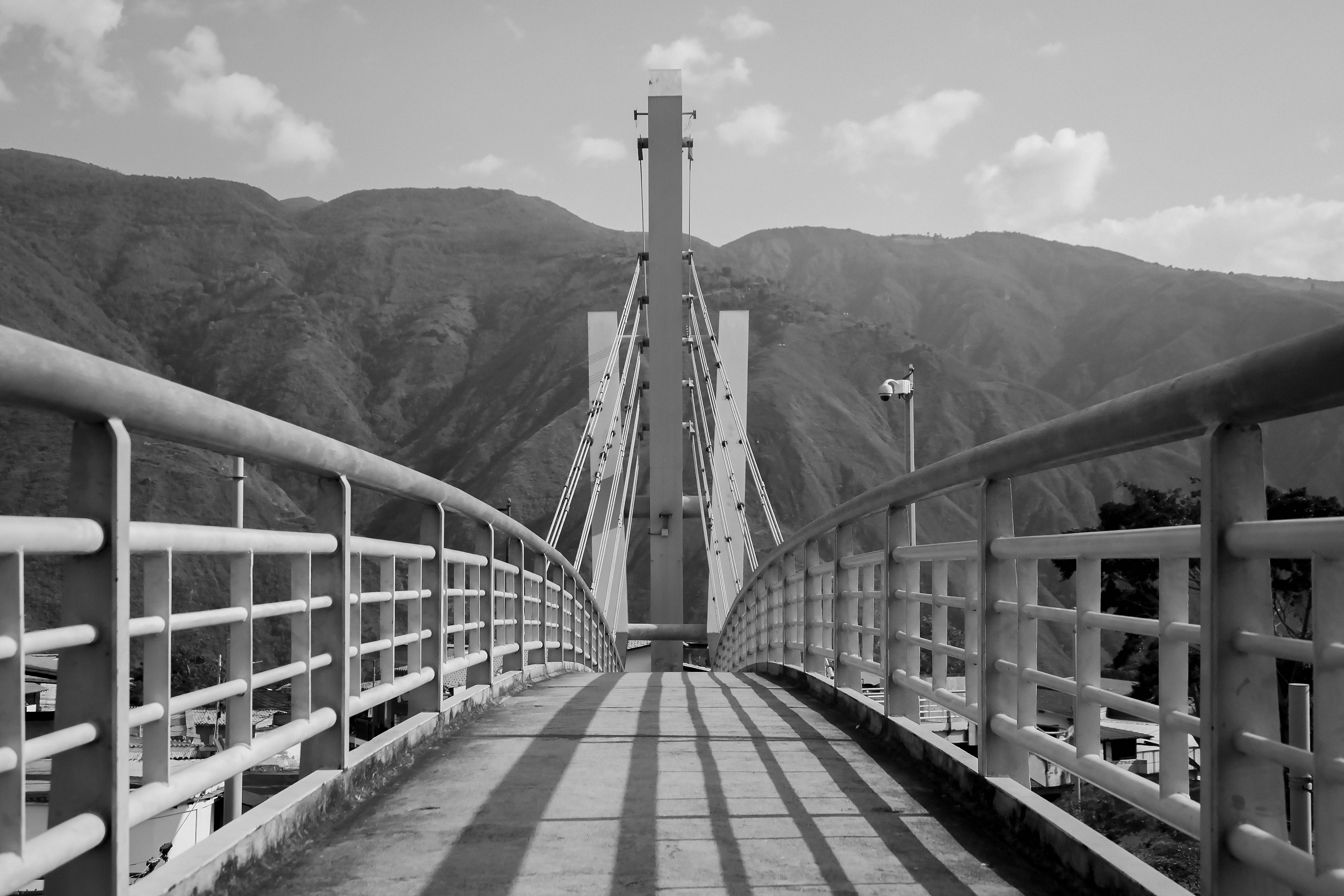 Monochrome Suspension Bridge with Mountain View · Free Stock Photo