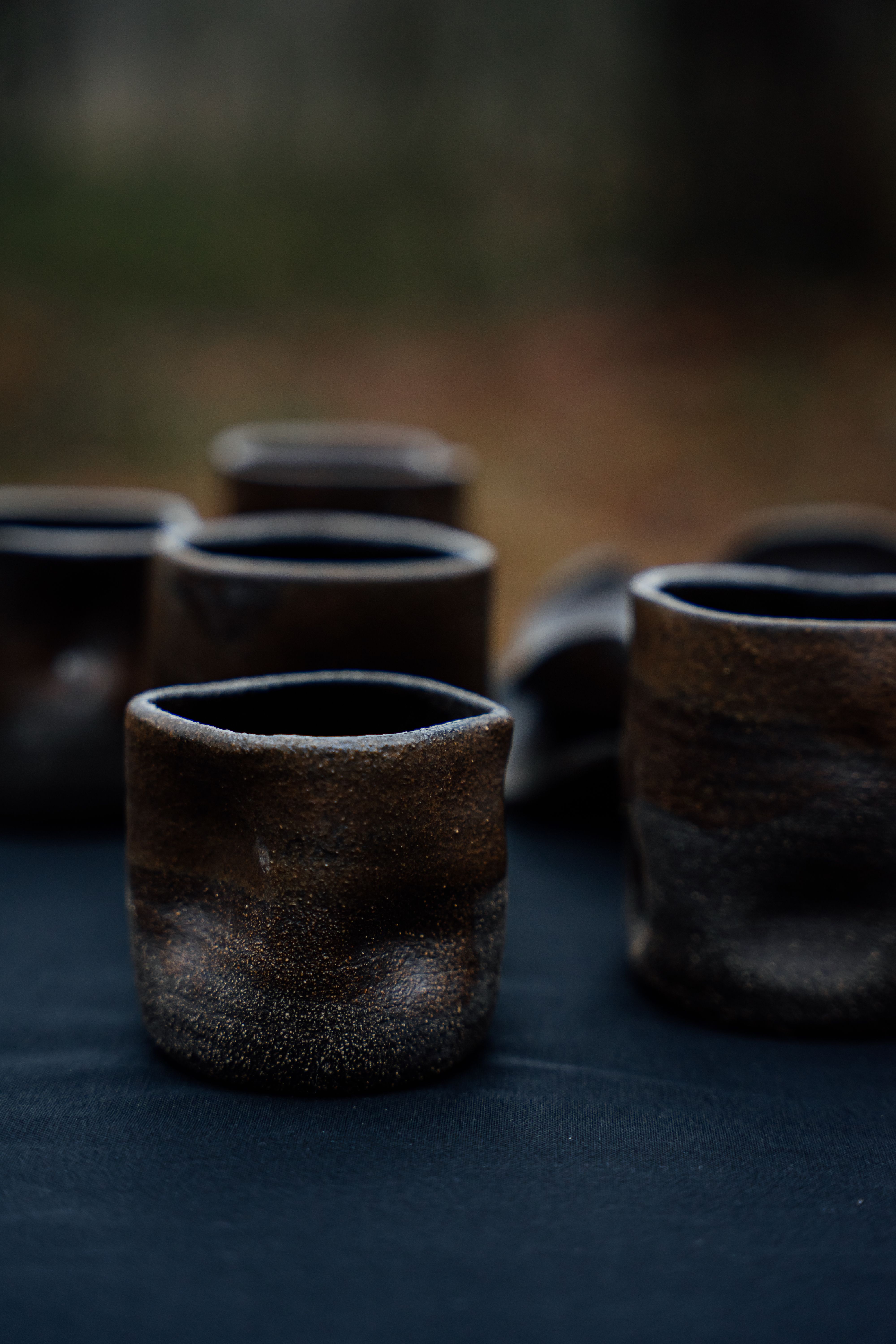 Rustic Handmade Ceramic Cups on Display · Free Stock Photo