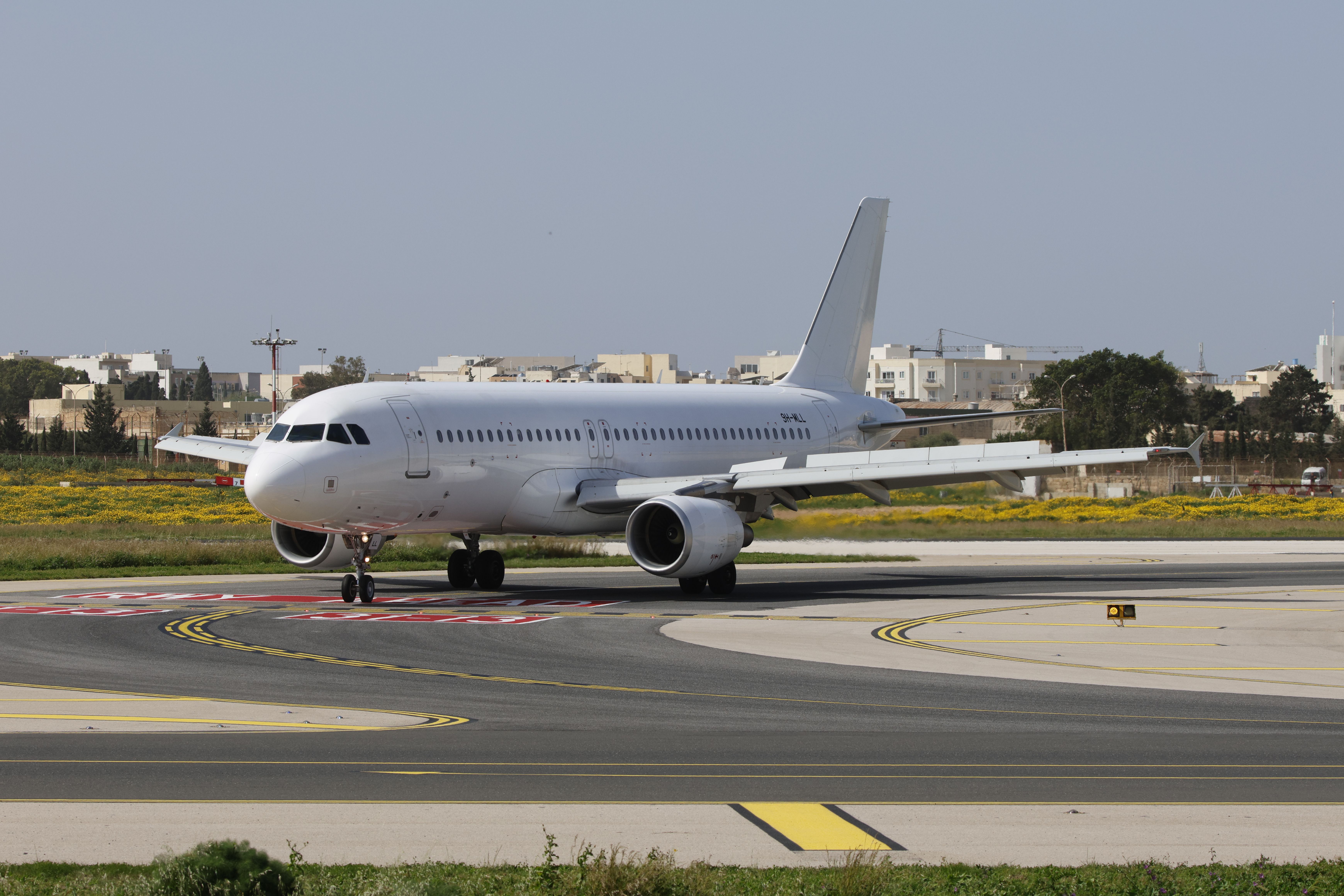 Commercial Airplane Taxiing on Airport Runway · Free Stock Photo