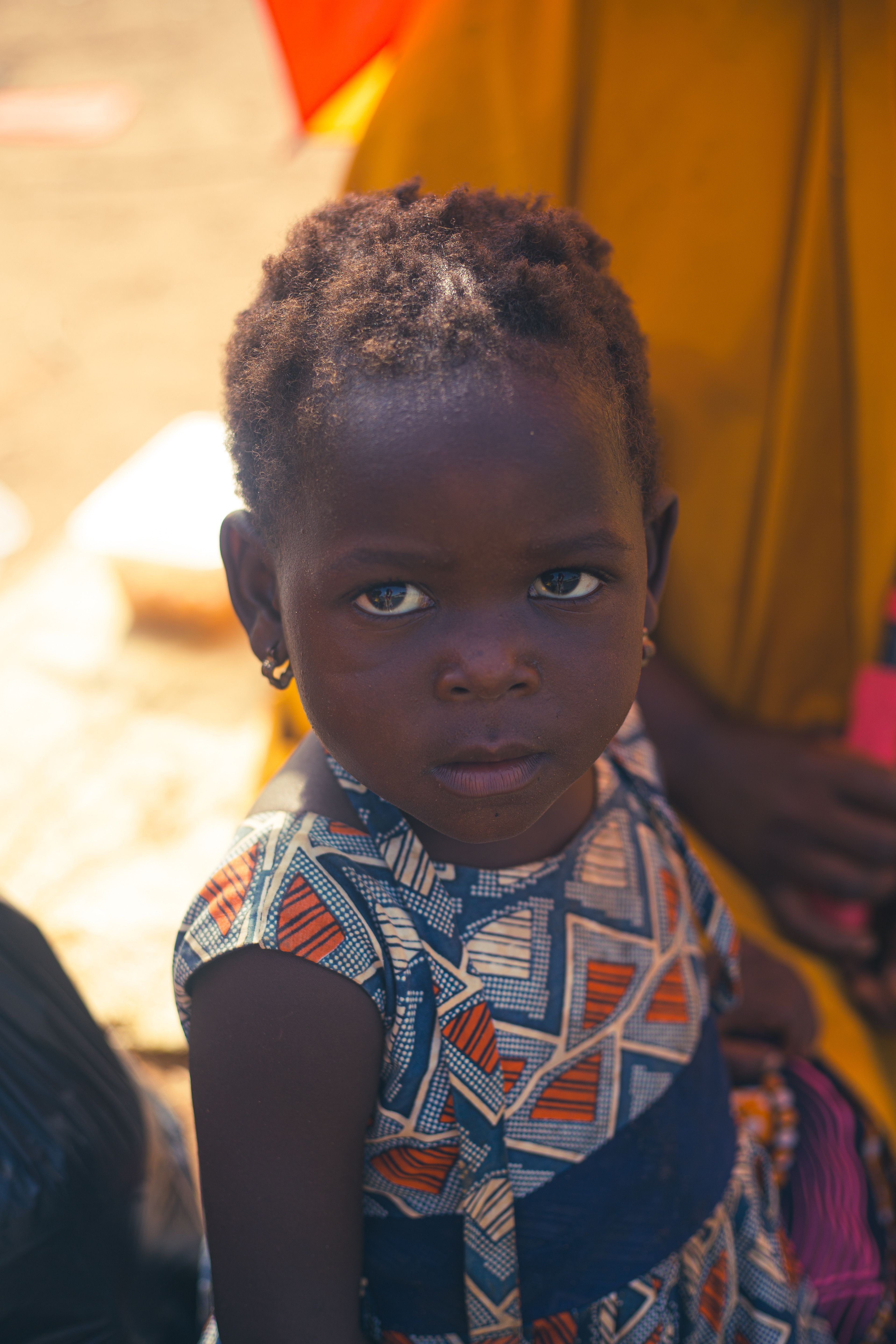 Portrait of a Young African Child in Patterned Dress · Free Stock Photo