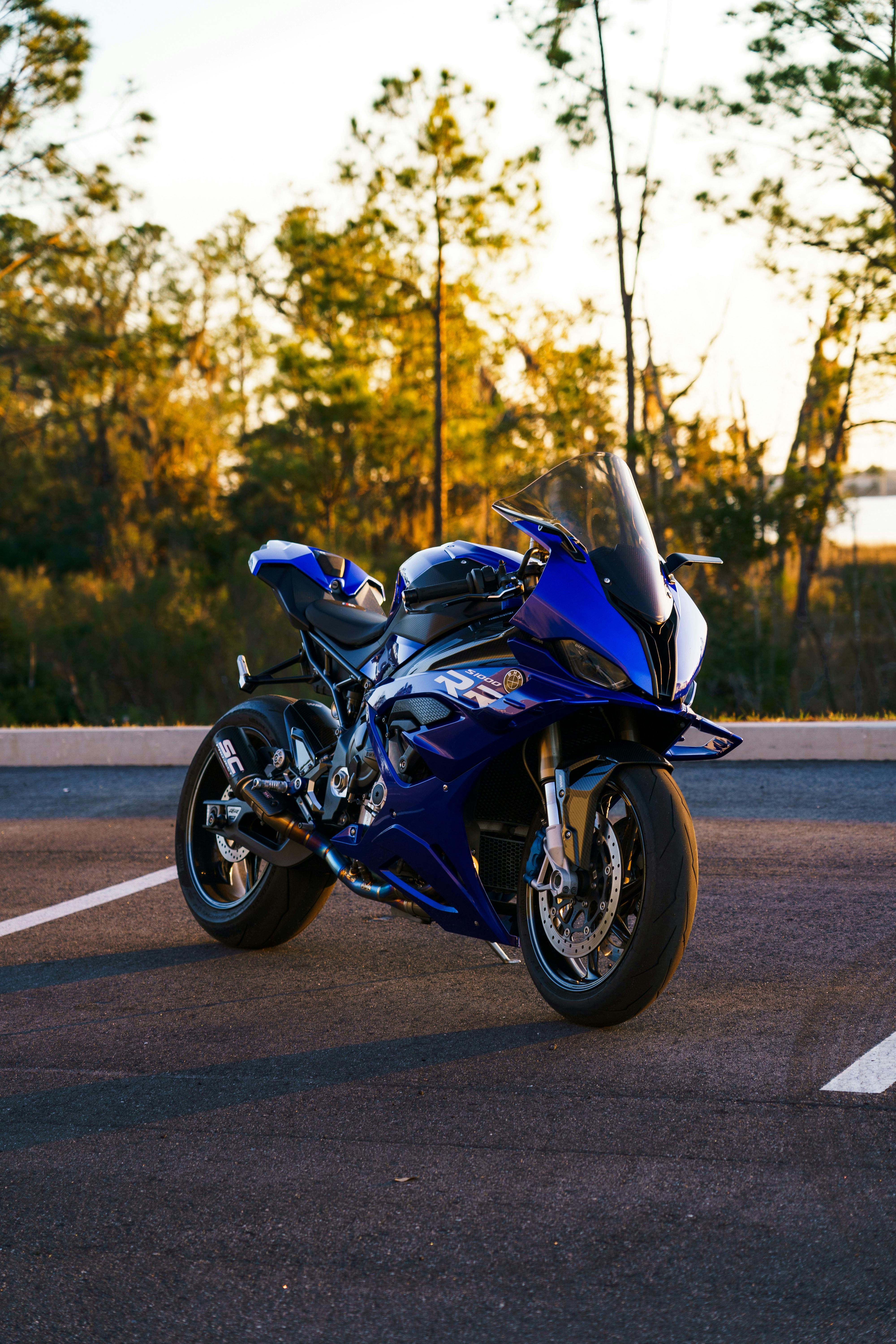 Blue sports motorcycle under sunset light in parking · Free Stock Photo