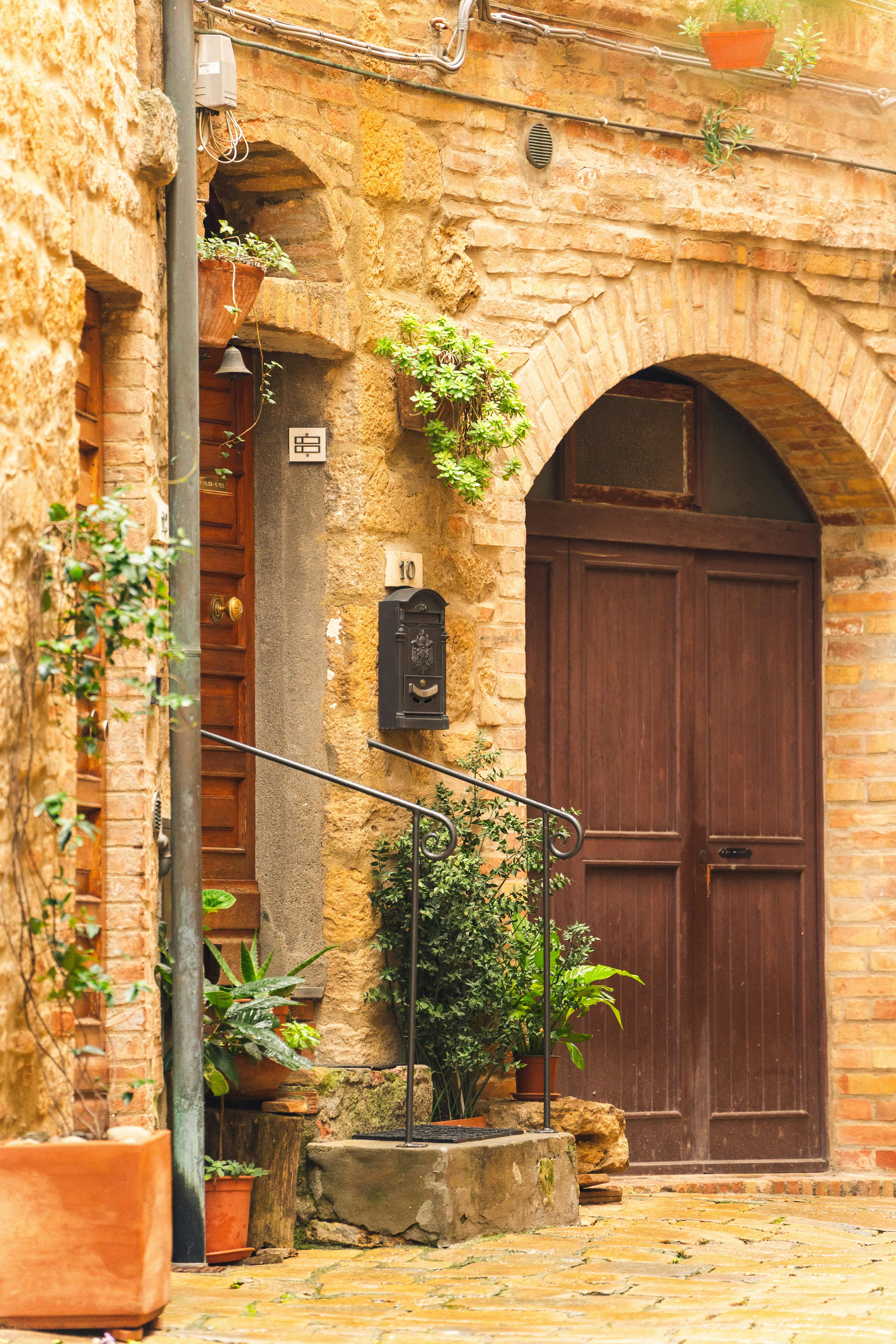 Charming Rustic Alleyway with Arched Doors · Free Stock Photo