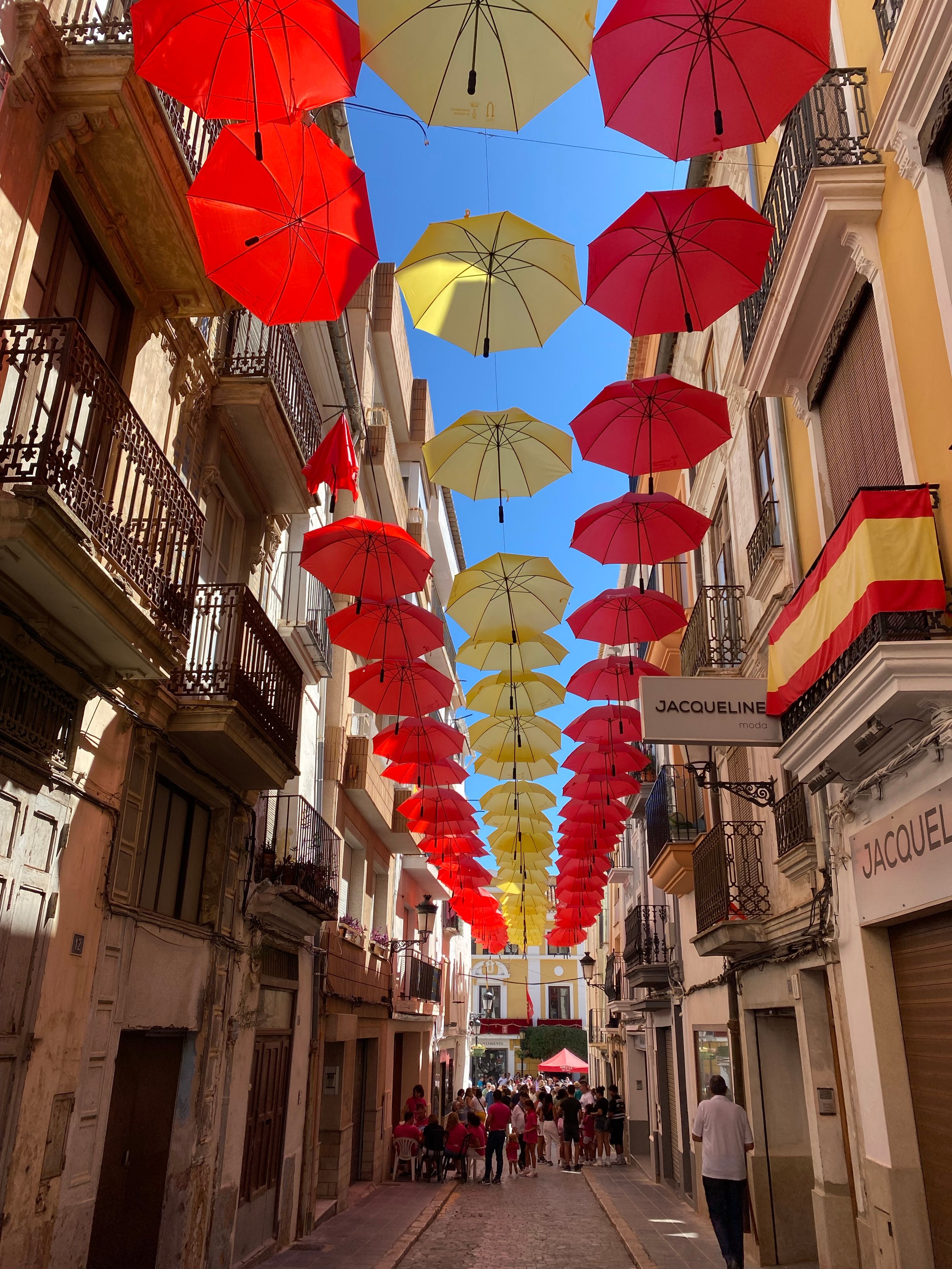 Colorful Umbrella Display on Narrow Street · Free Stock Photo