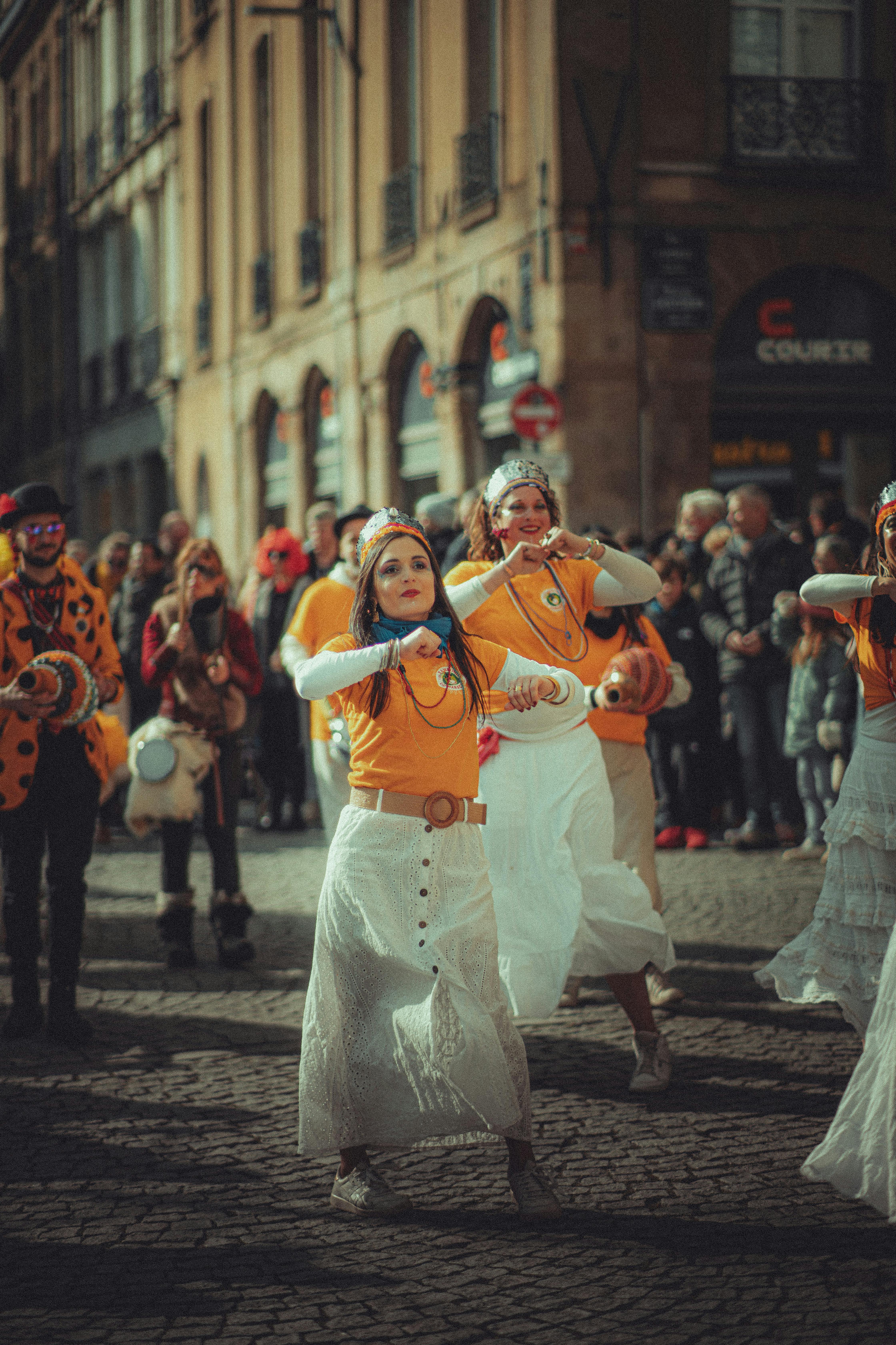 Vibrant Street Parade with Joyful Dancers · Free Stock Photo