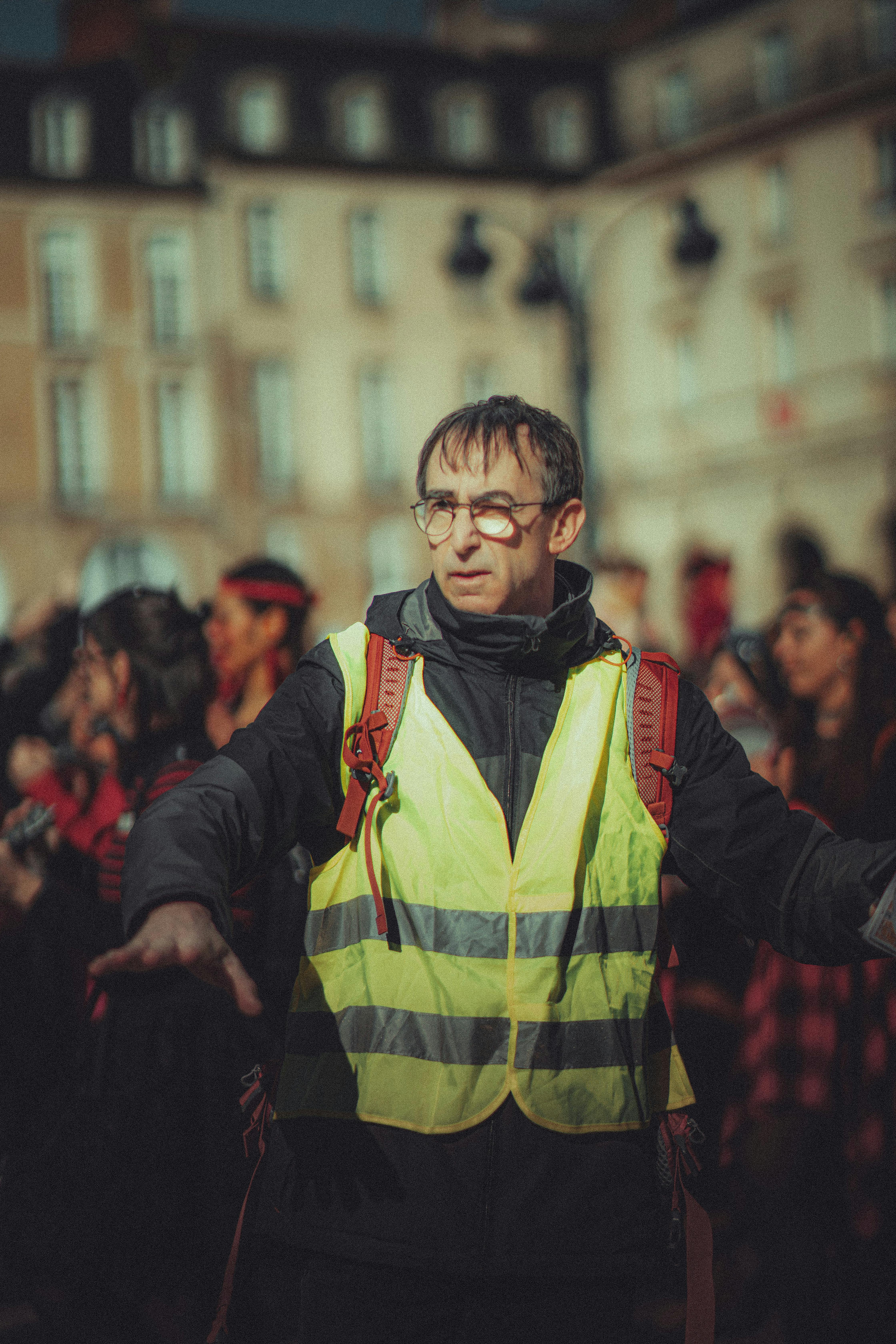 Man in High Visibility Vest at Outdoor Event · Free Stock Photo