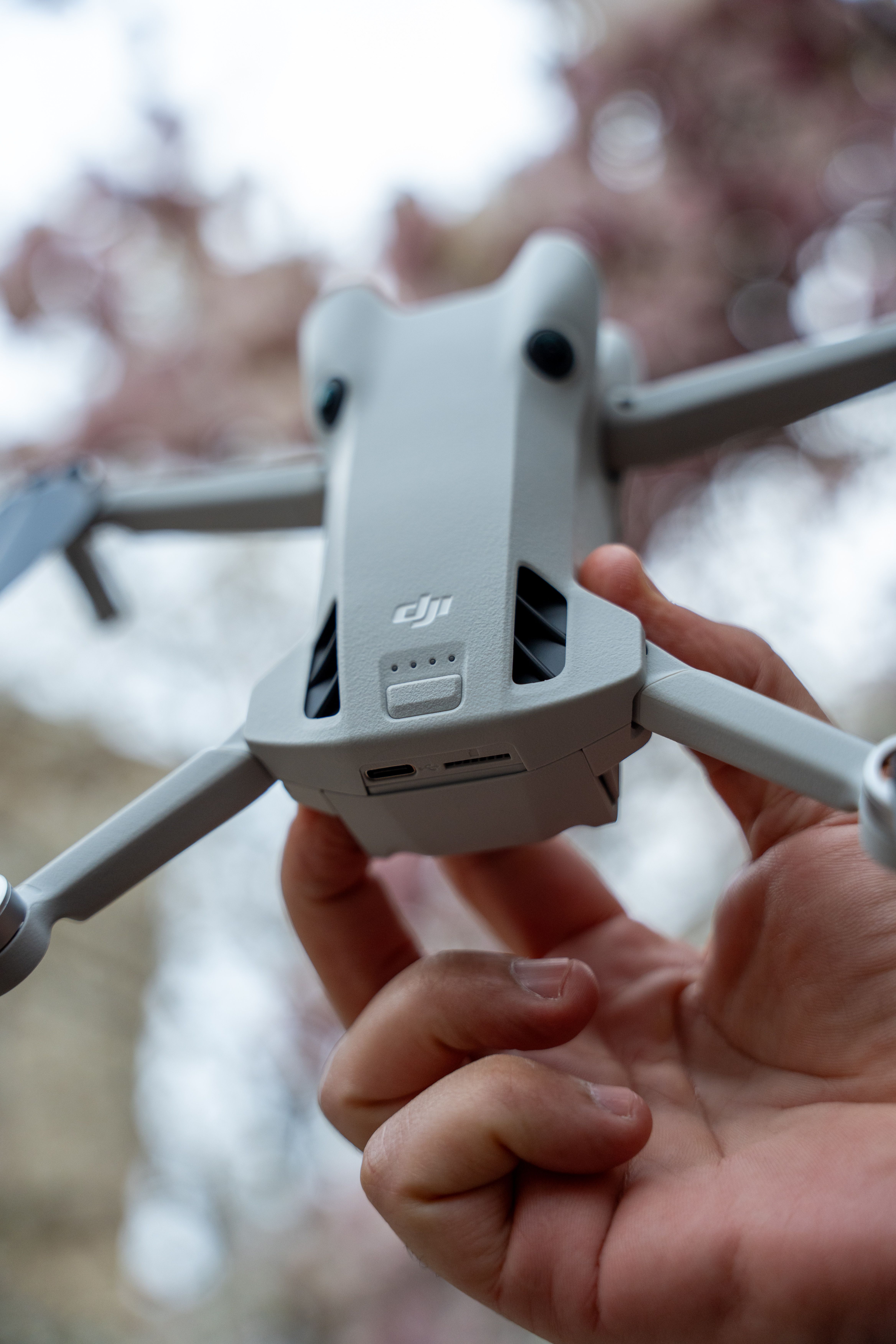 Close-Up of Hand Holding a DJI Drone Outdoors · Free Stock Photo