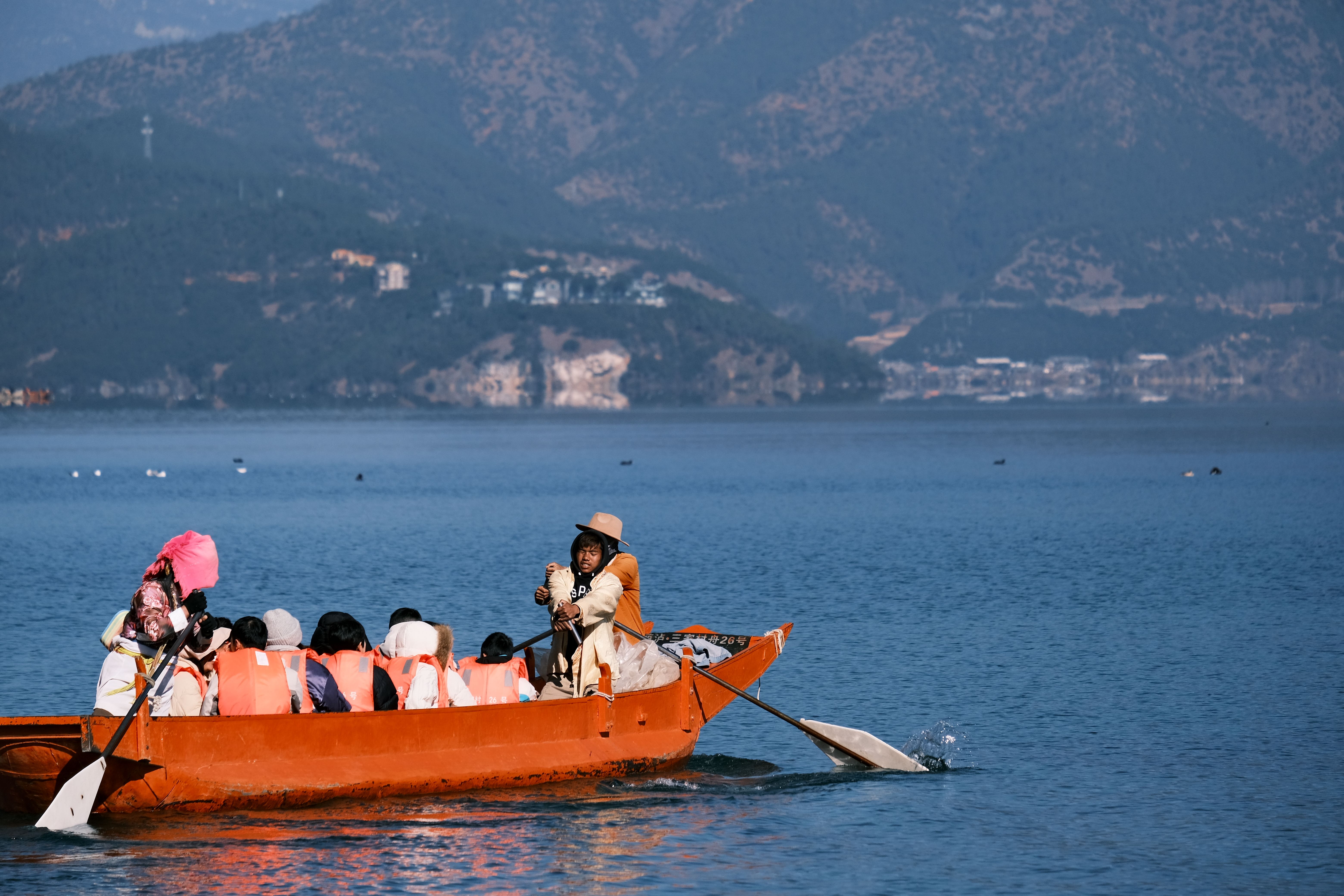 Serene Boat Ride on a Mountain Lake · Free Stock Photo