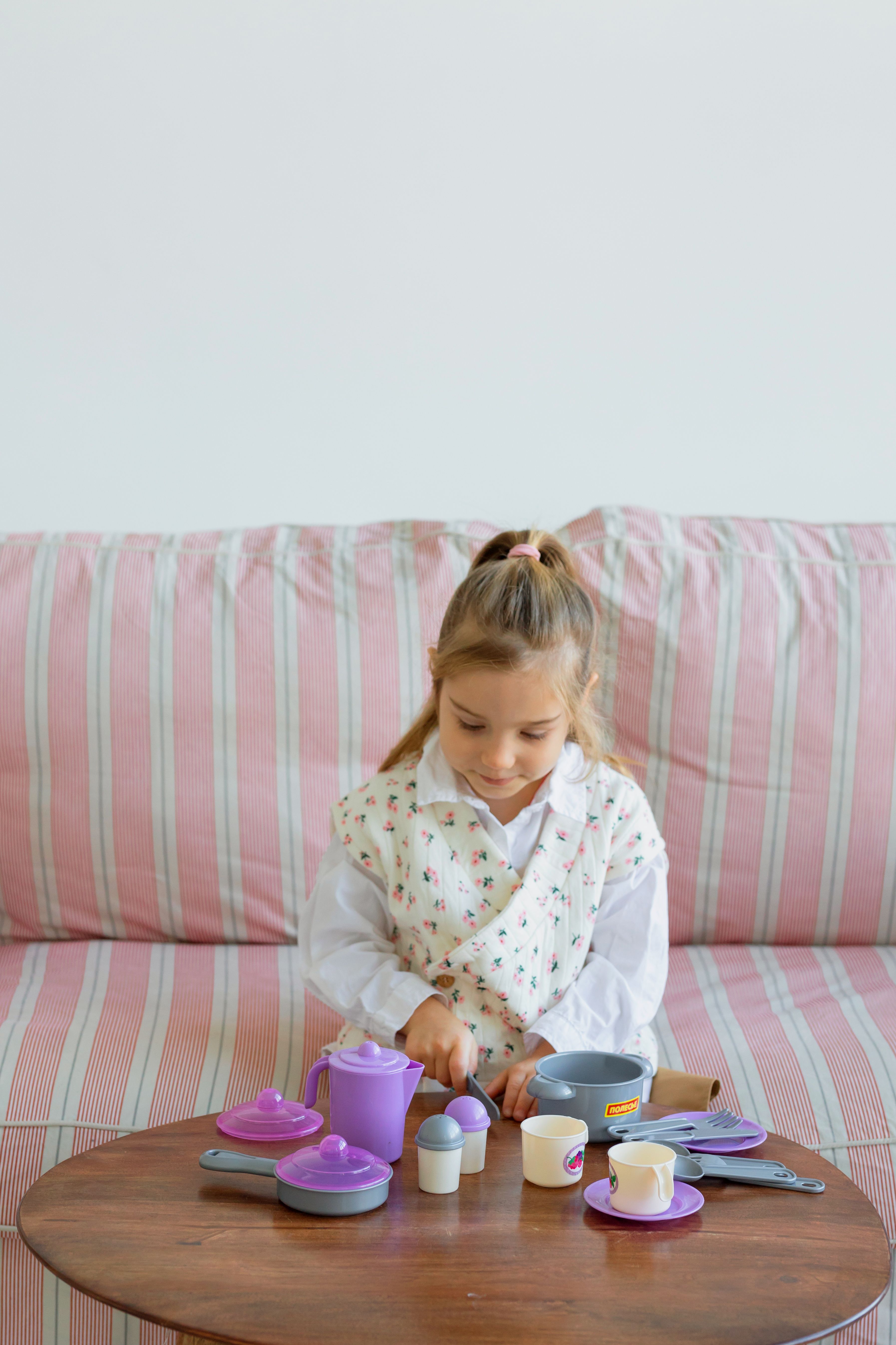 Young Girl Playing with Tea Set at Home · Free Stock Photo