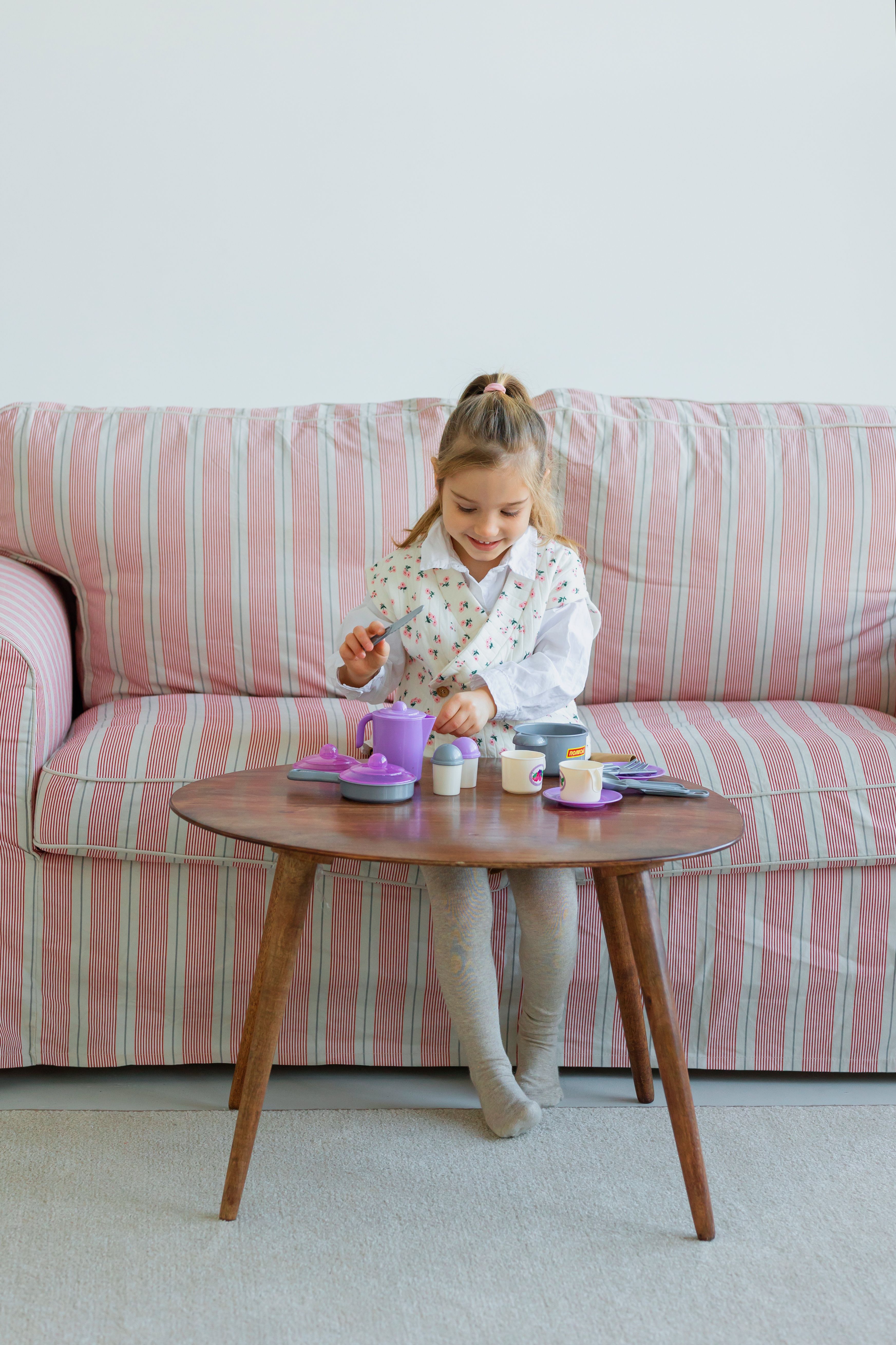Young Girl Enjoying a Tea Party with Toy Set · Free Stock Photo