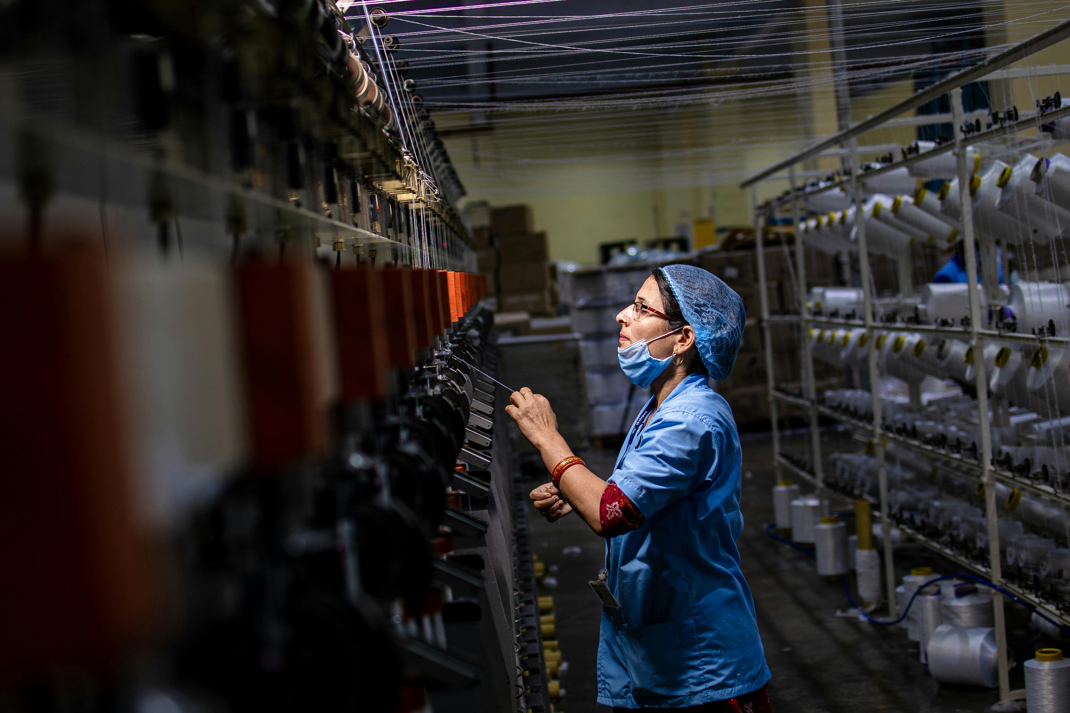 Female Textile Worker in Manufacturing Facility · Free Stock Photo