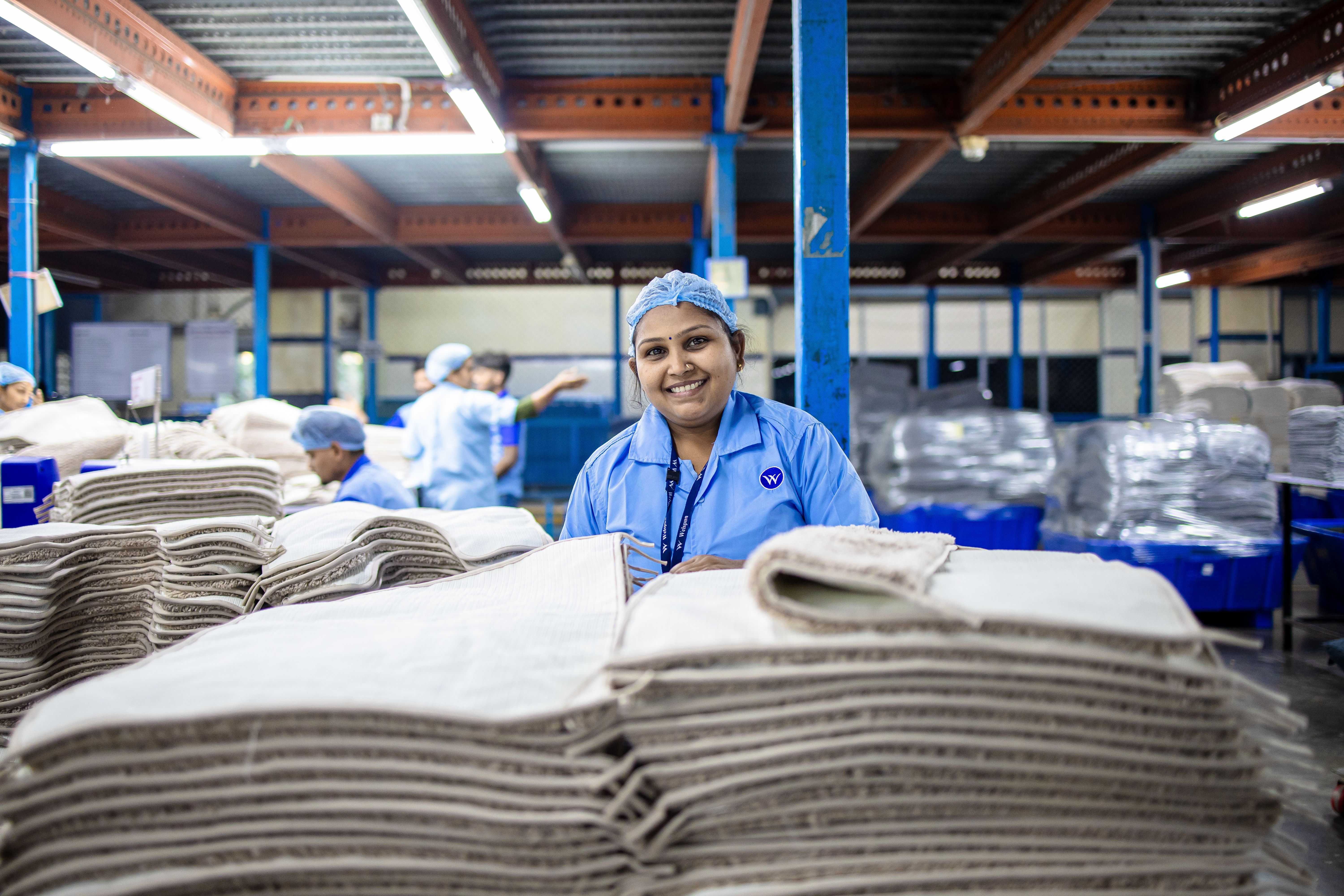 Smiling Factory Worker in Textile Industry · Free Stock Photo
