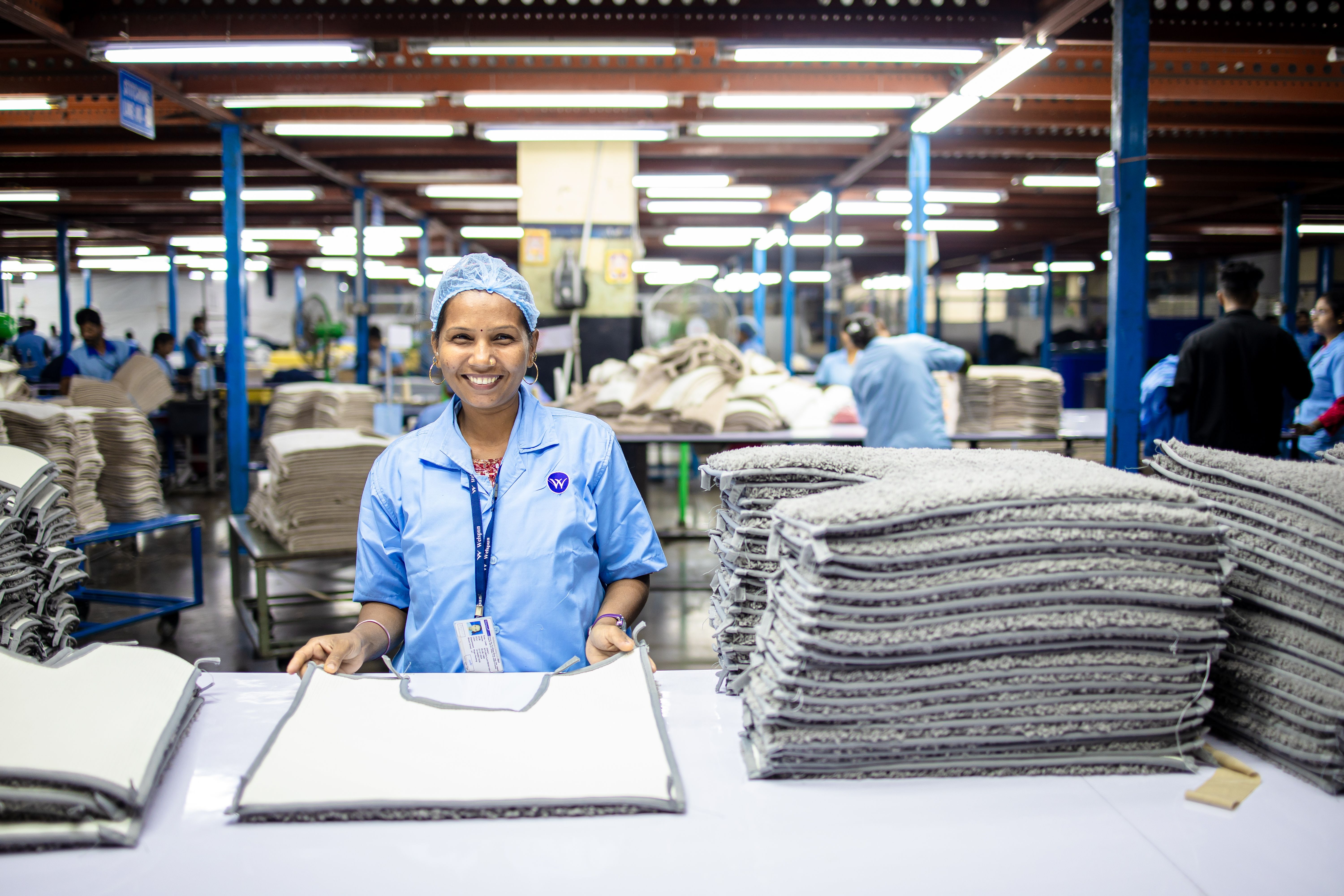 Smiling Female Factory Worker in Textile Industry · Free Stock Photo