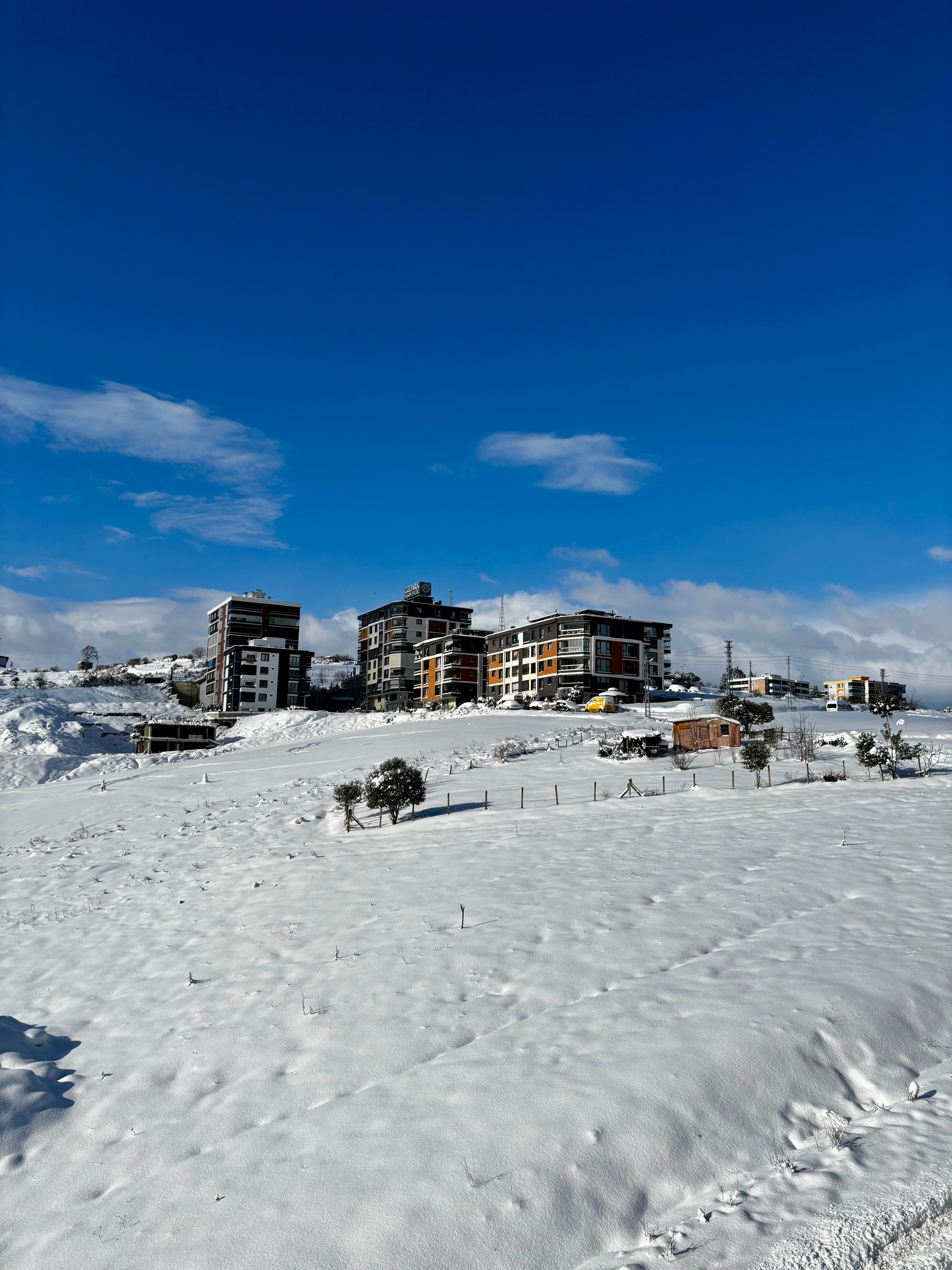 Snow-Covered Urban Landscape Under Clear Blue Sky · Free Stock Photo