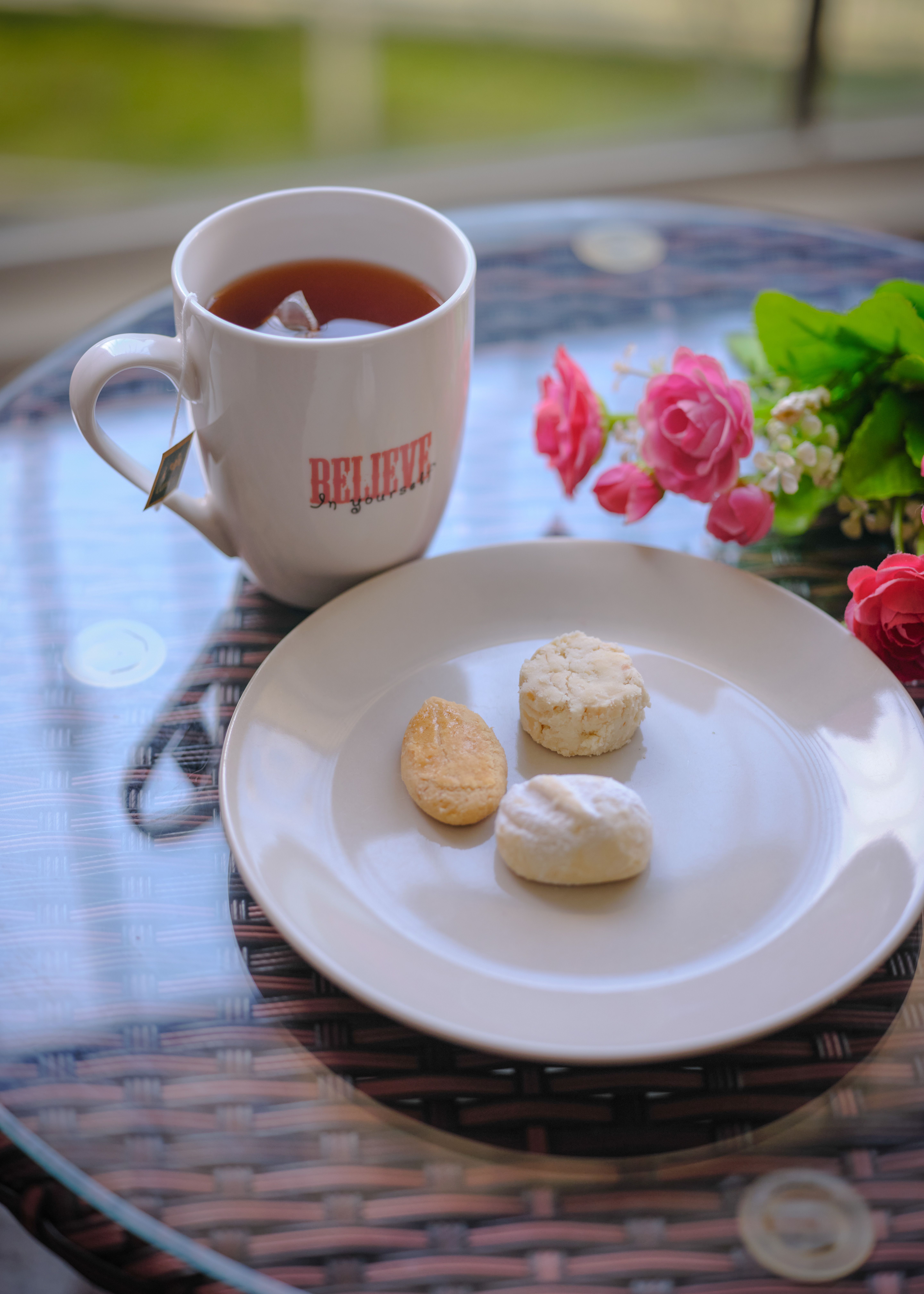 Cozy Tea and Cookies with Floral Arrangement · Free Stock Photo