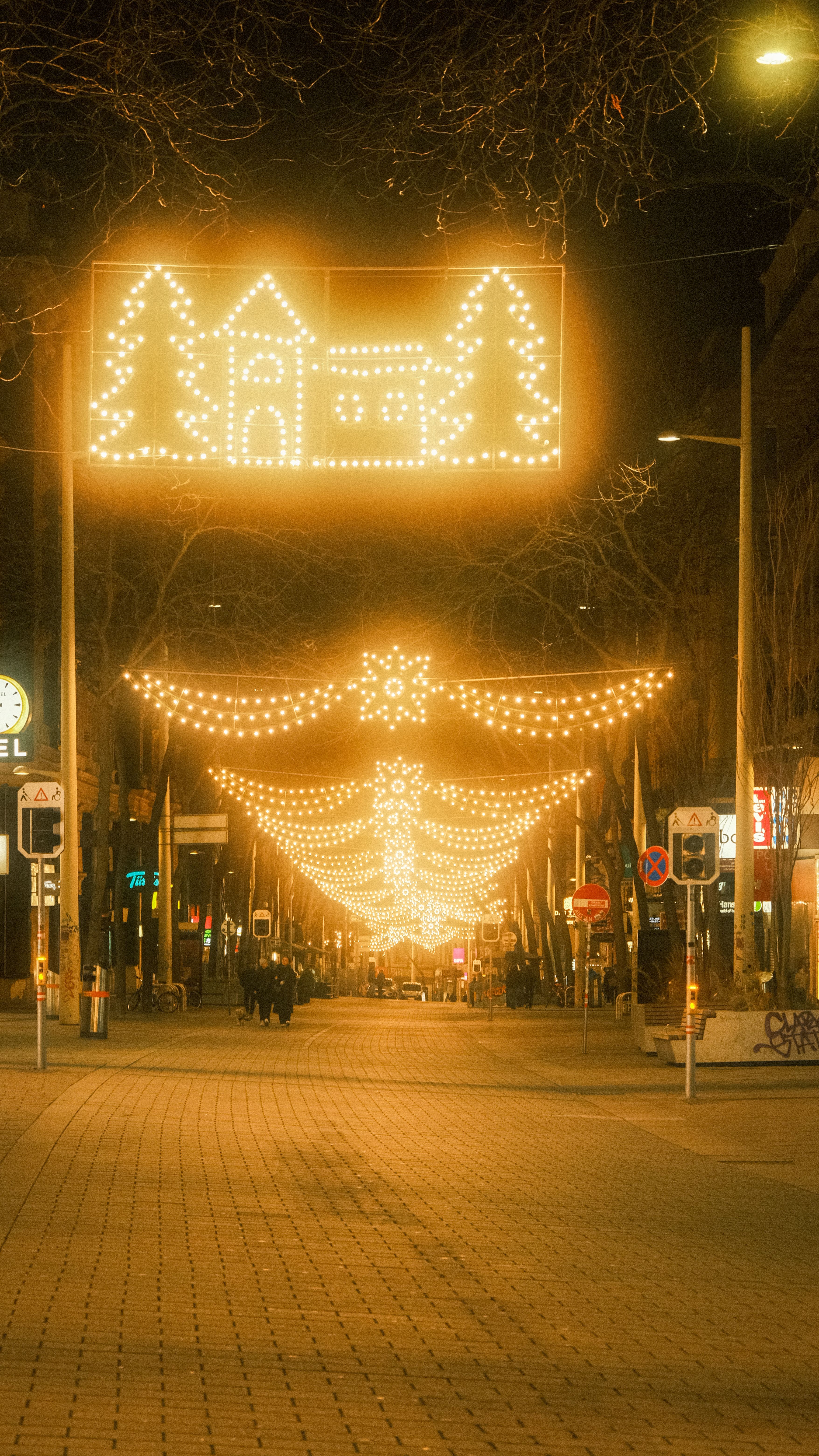 Festive Street with Illuminated Holiday Lights at Night · Free Stock Photo