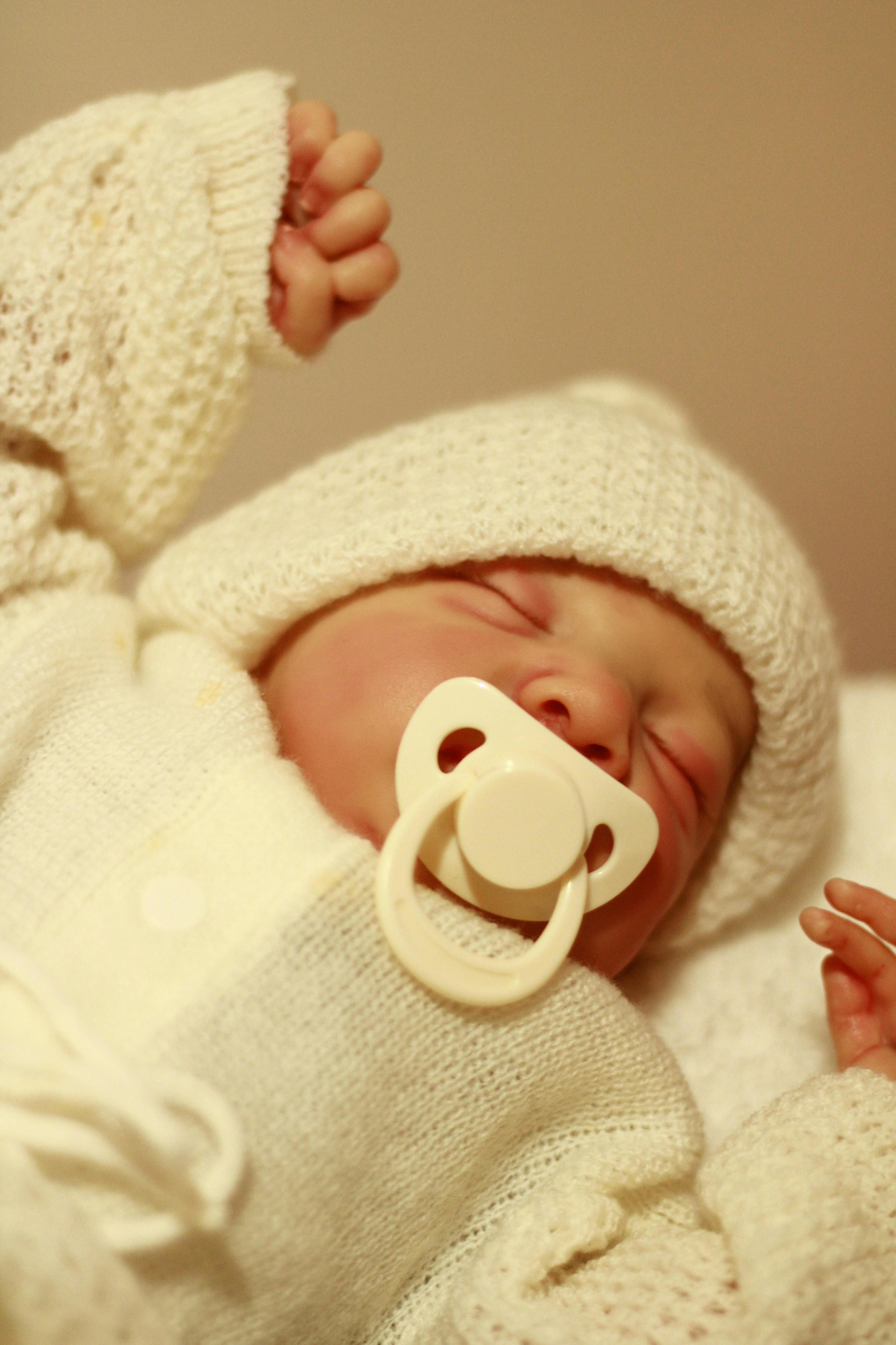 Peaceful Newborn Baby Sleeping in Knitwear · Free Stock Photo