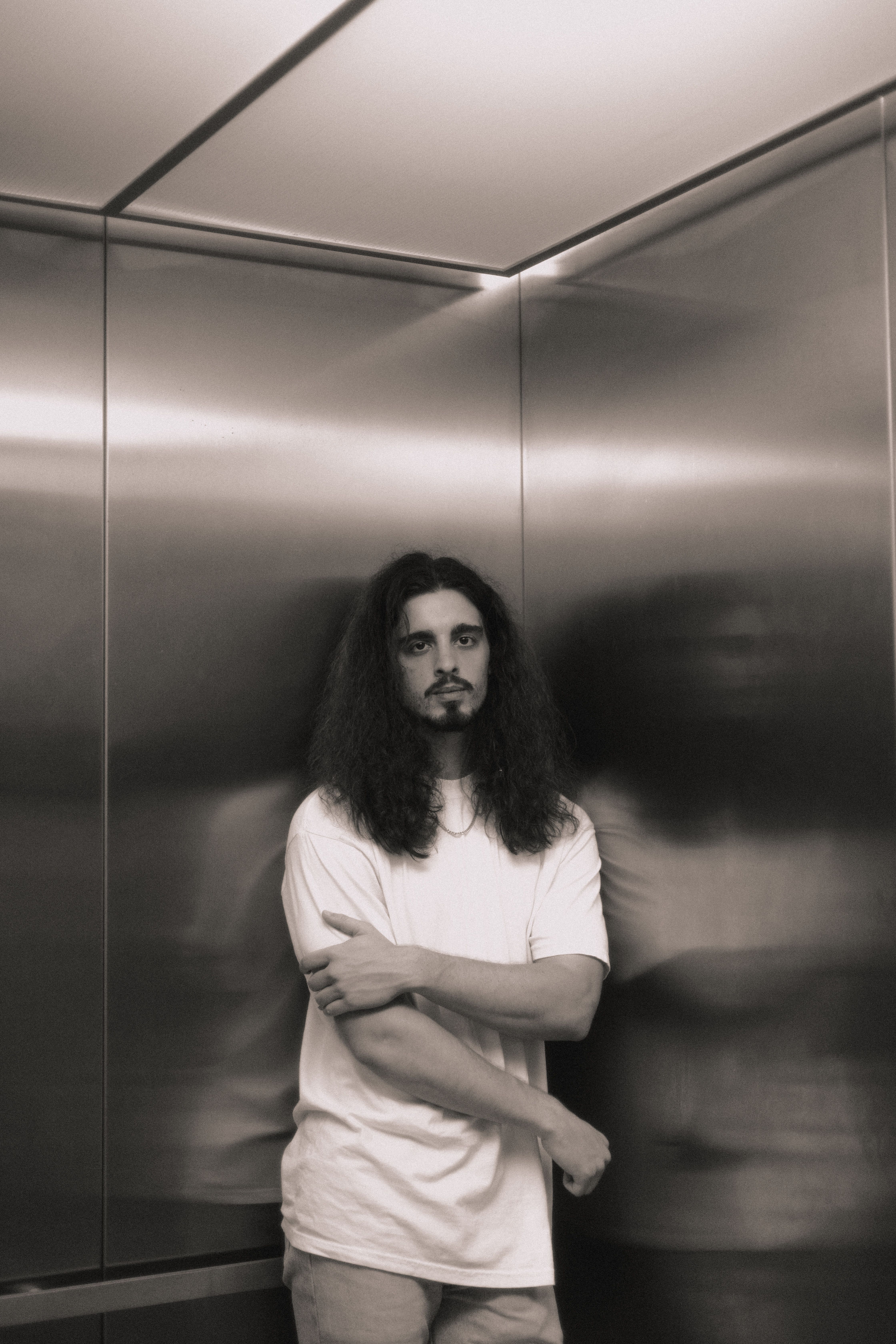Portrait of a Man with Long Hair in an Elevator · Free Stock Photo