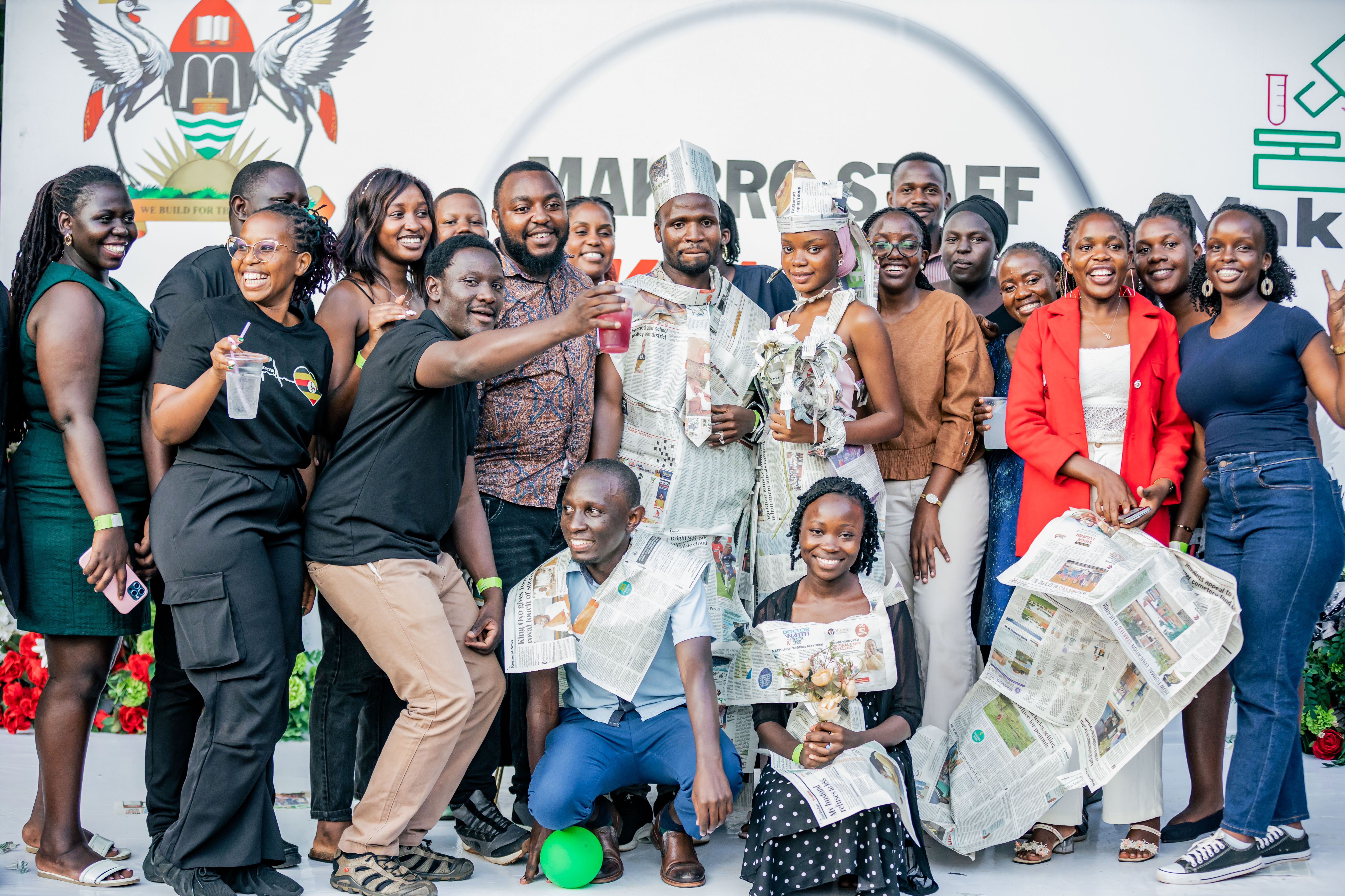 Lively Group Celebration in Unique Newspaper Attire · Free Stock Photo