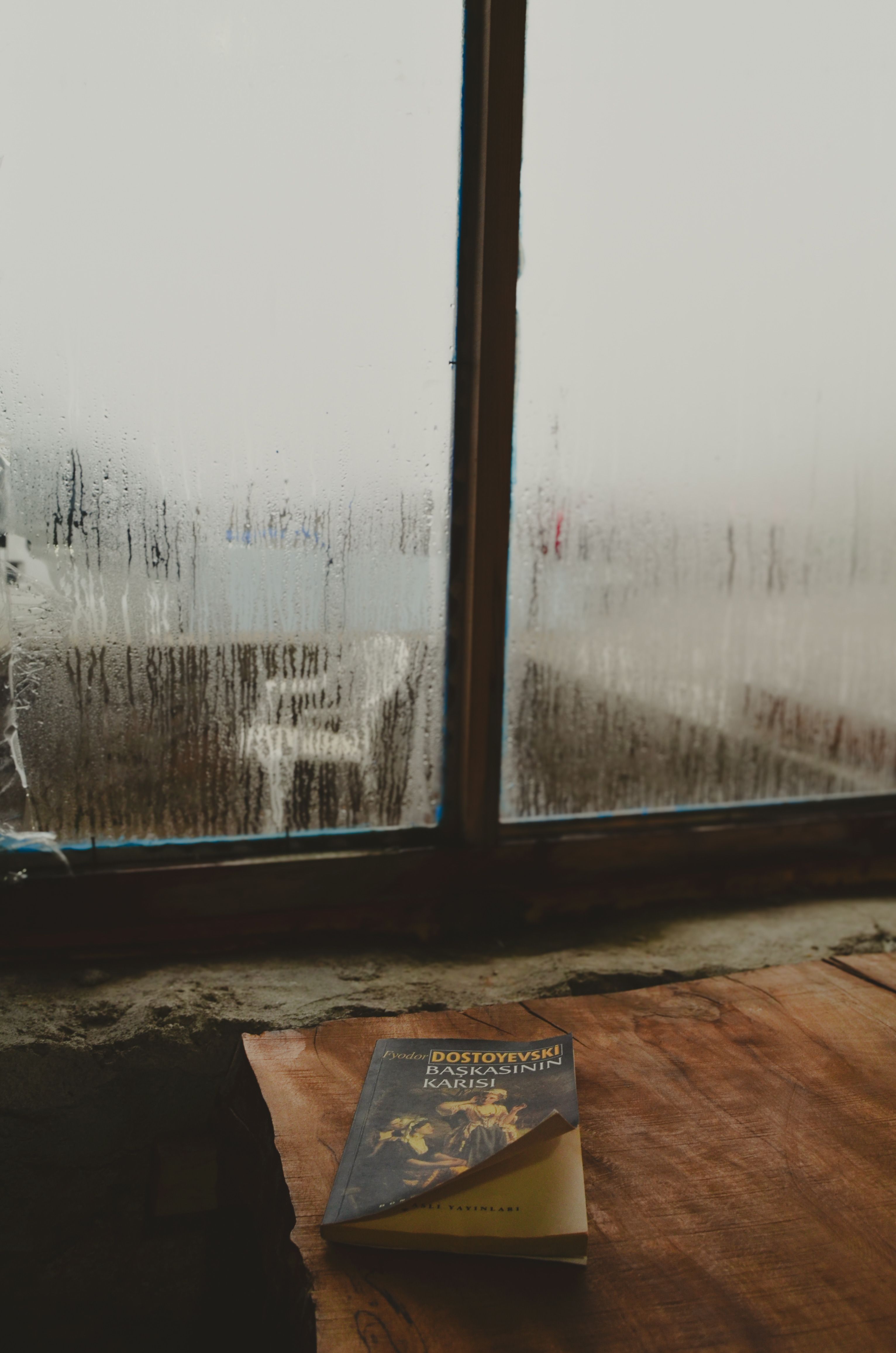 Cozy Reading Spot with Foggy Window View · Free Stock Photo