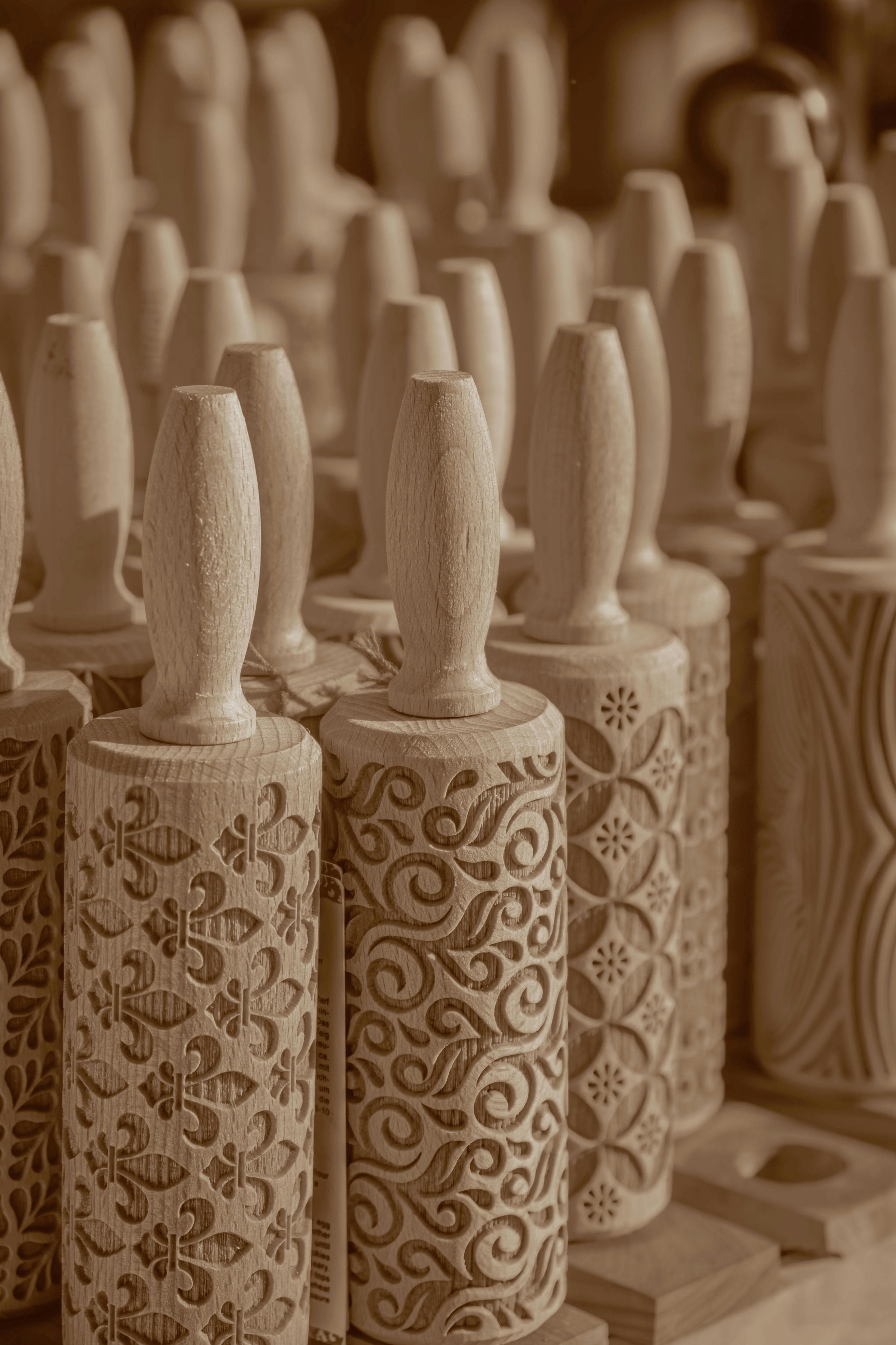 Intricately Carved Wooden Rolling Pins Display · Free Stock Photo