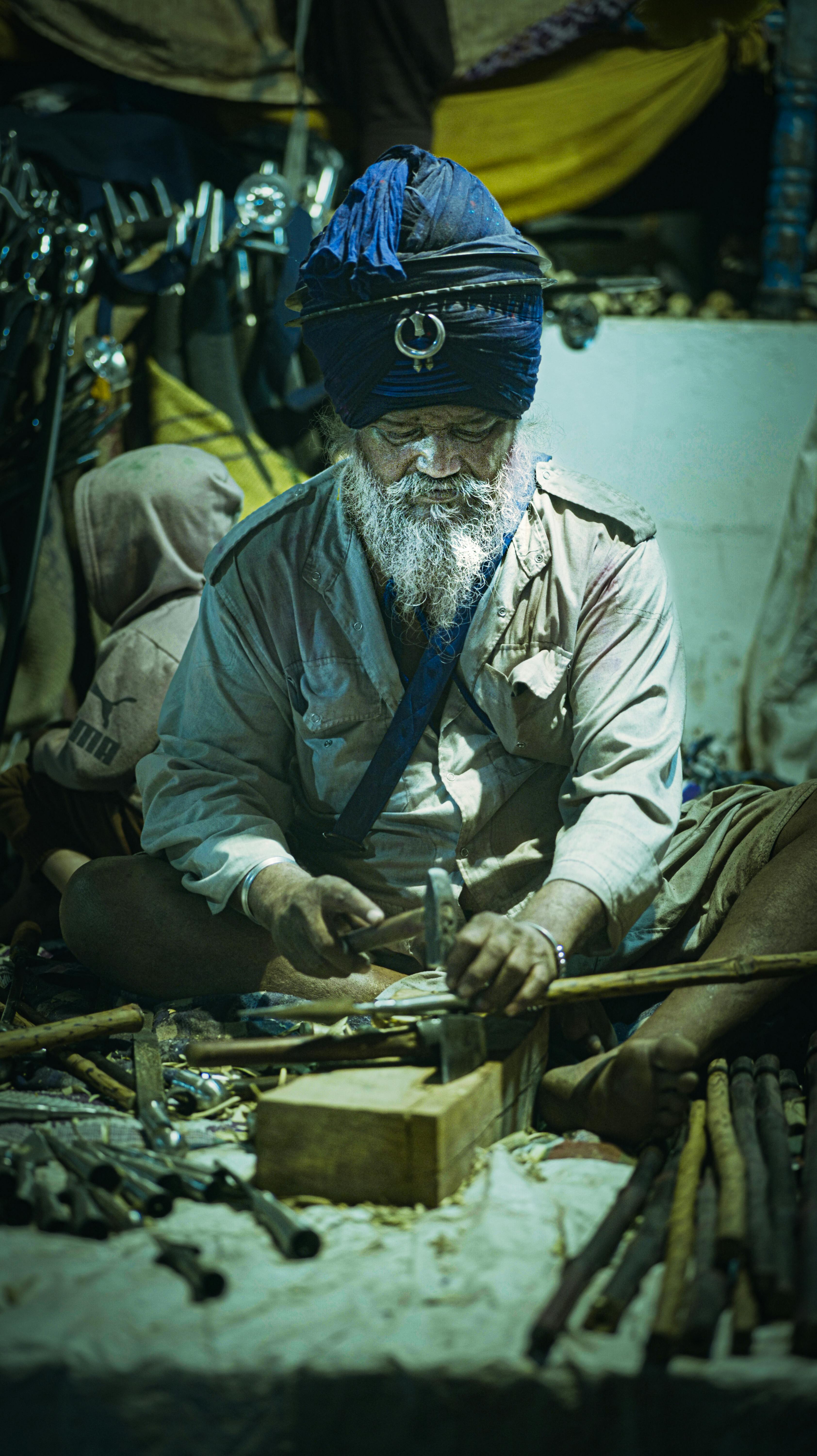 Nihang Sikh Craftsman Working on Traditional Weapons · Free Stock Photo