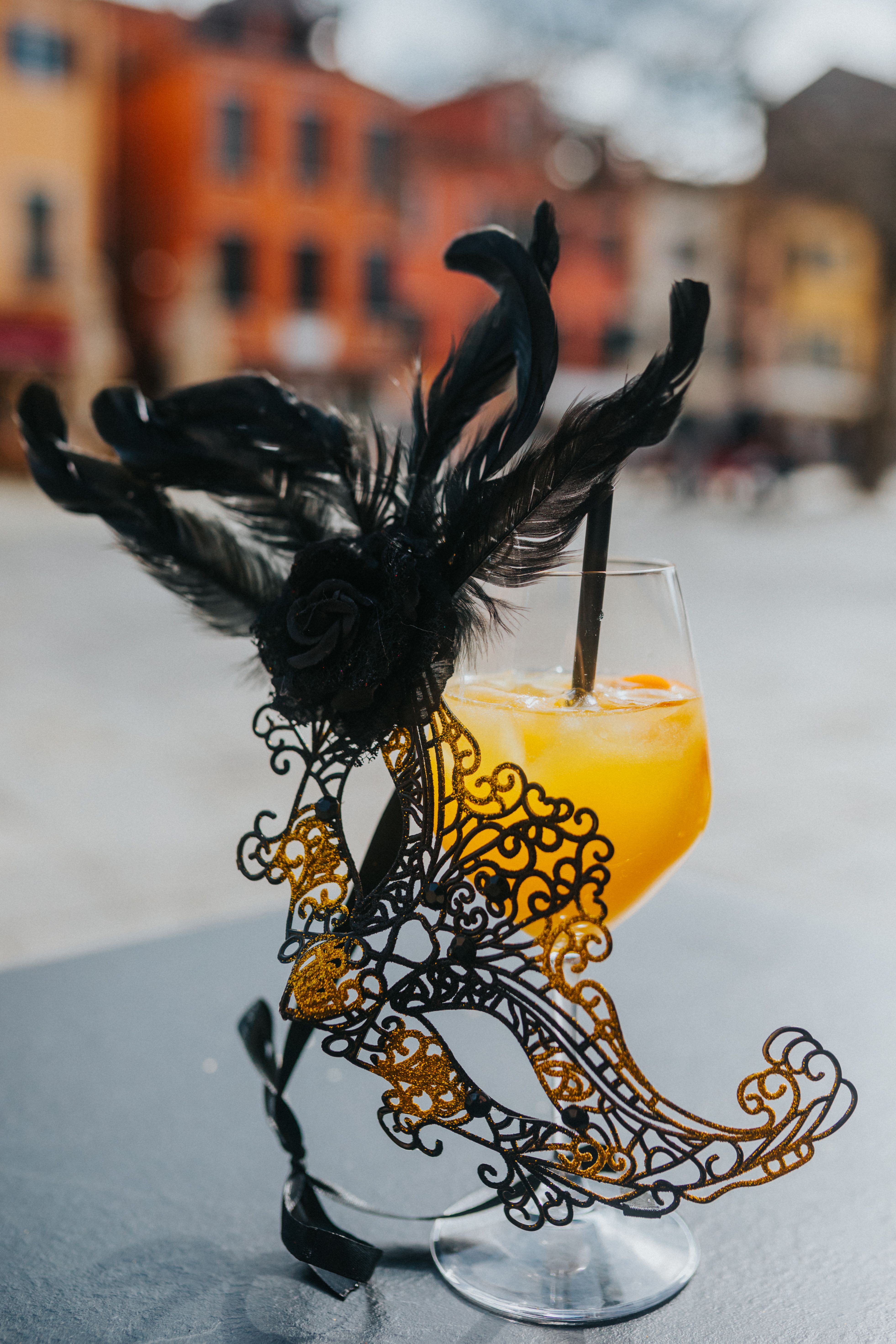 Elegant Venetian Mask and Cocktail in Sunny Plaza · Free Stock Photo