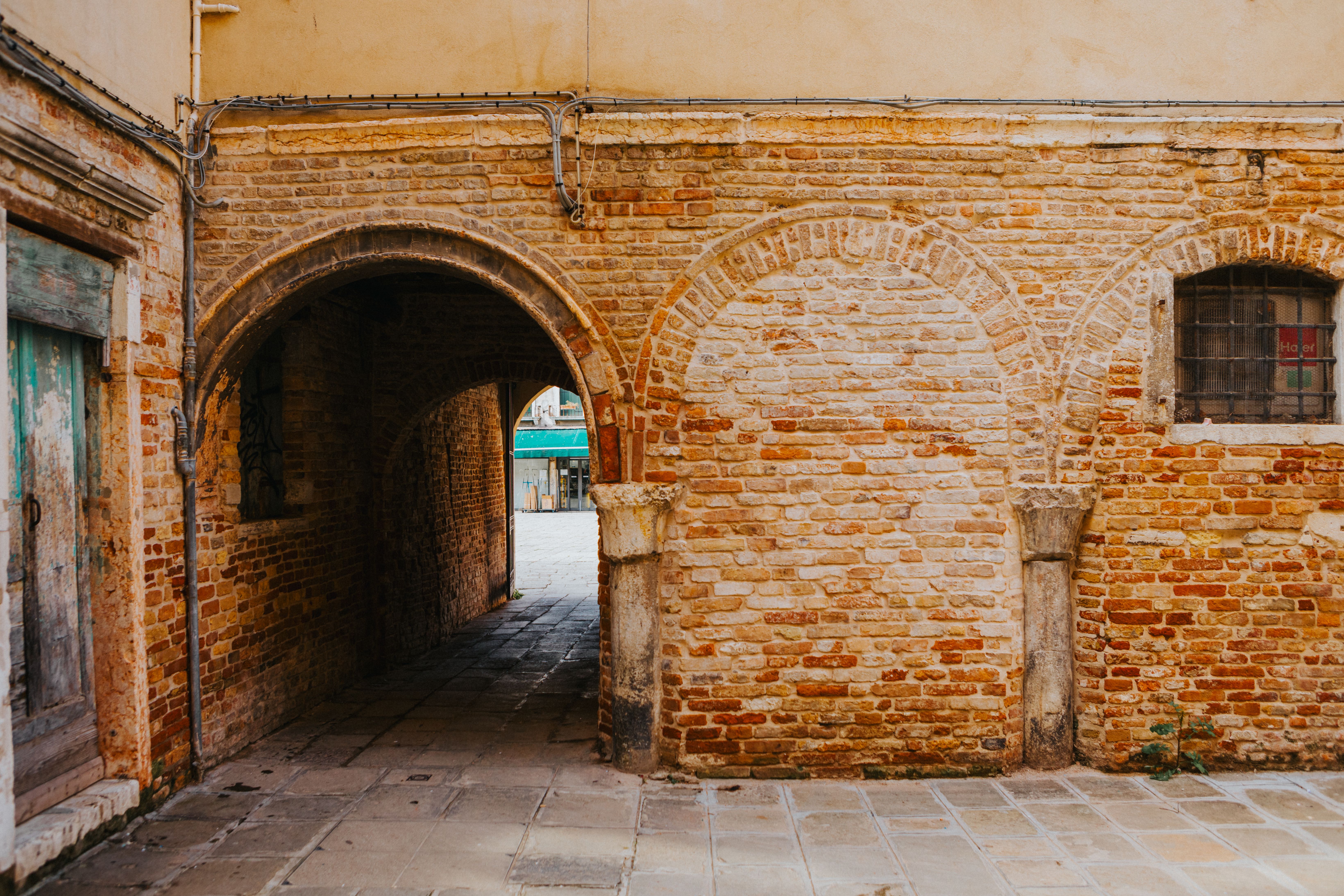 Historic Archway in Venice Brick Wall · Free Stock Photo
