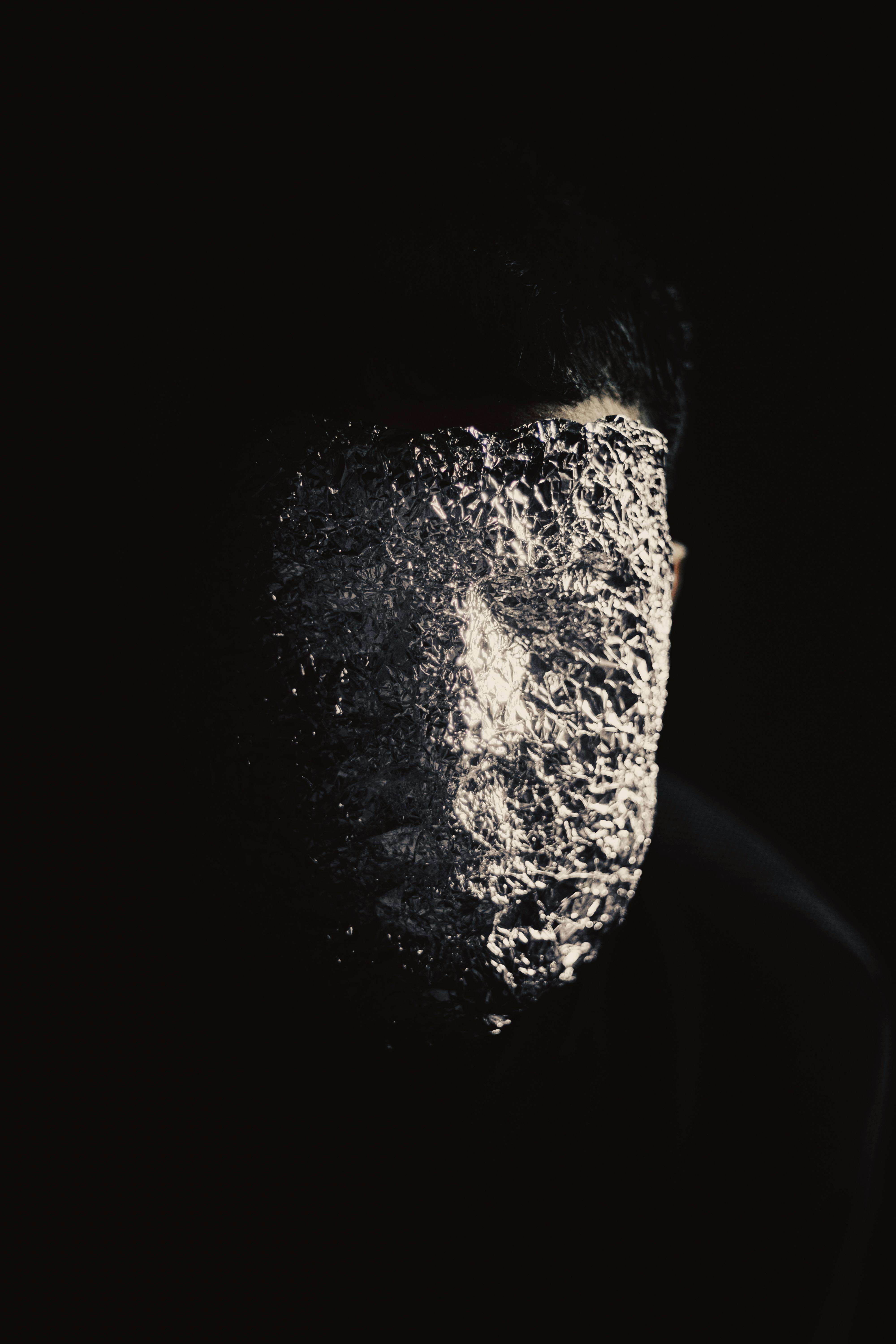 Mysterious Portrait with Tinfoil Mask in Darkness · Free Stock Photo