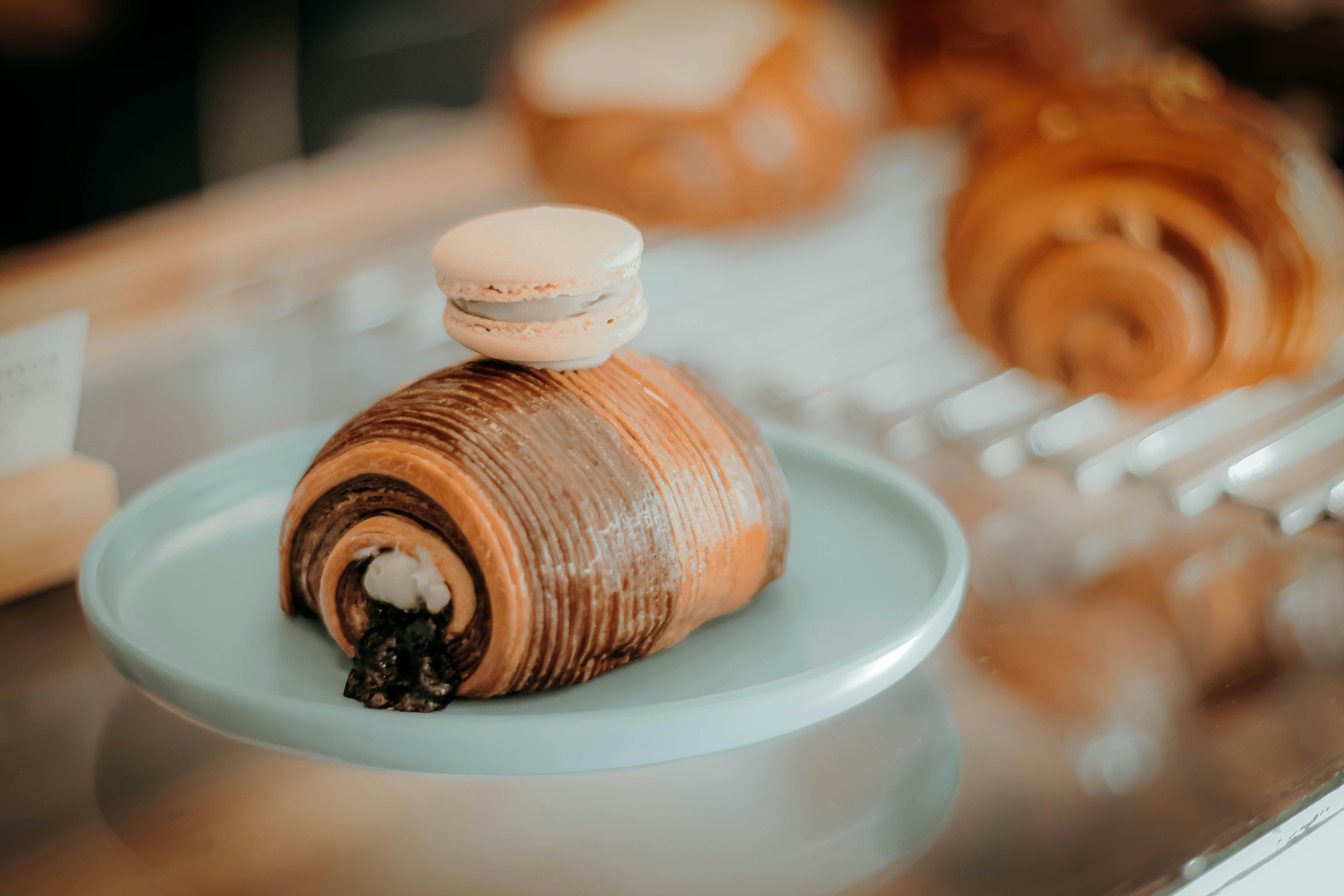 Delicious pastry with macaron topping on a plate · Free Stock Photo