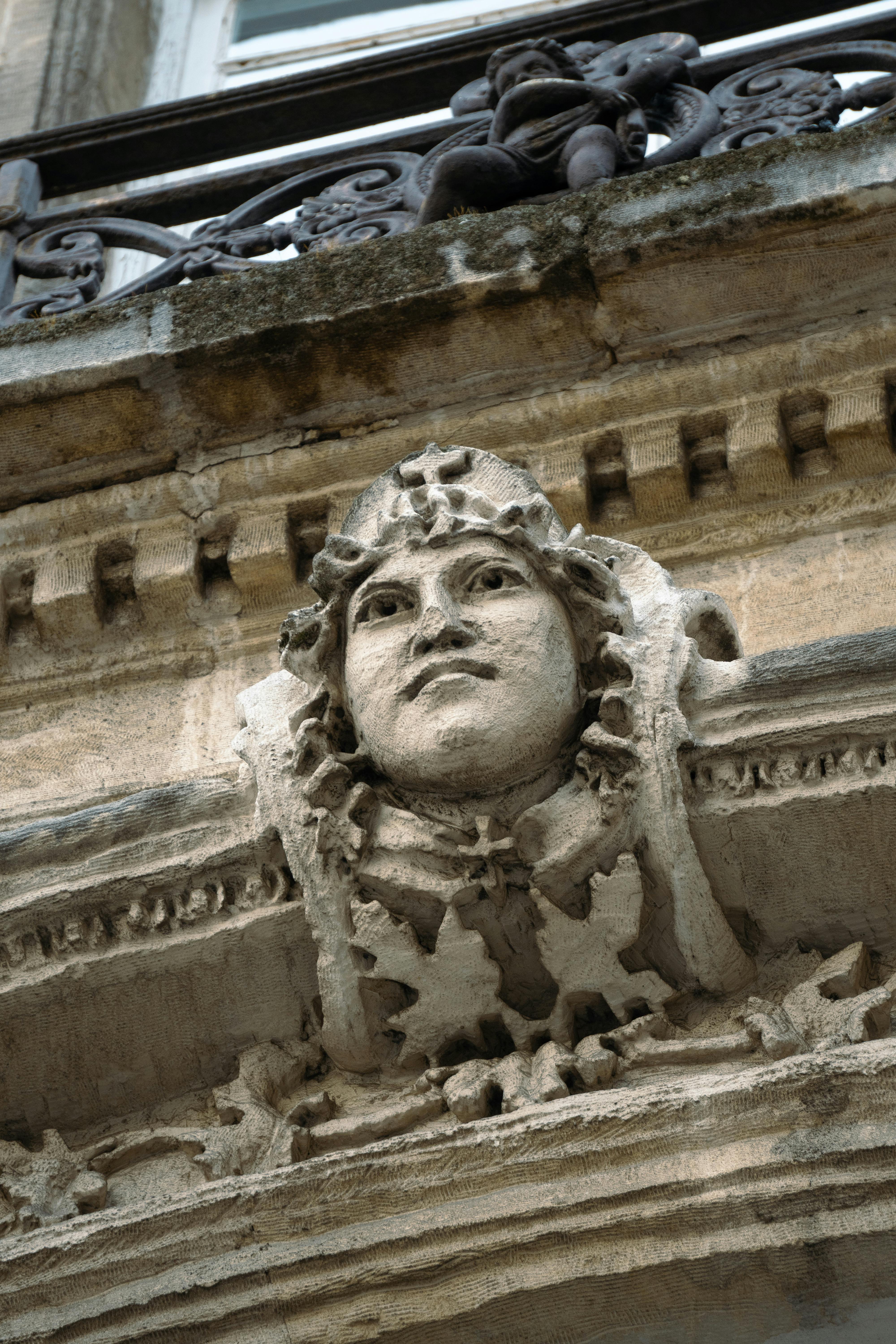 Ornate Architectural Stone Face Carving Detail · Free Stock Photo