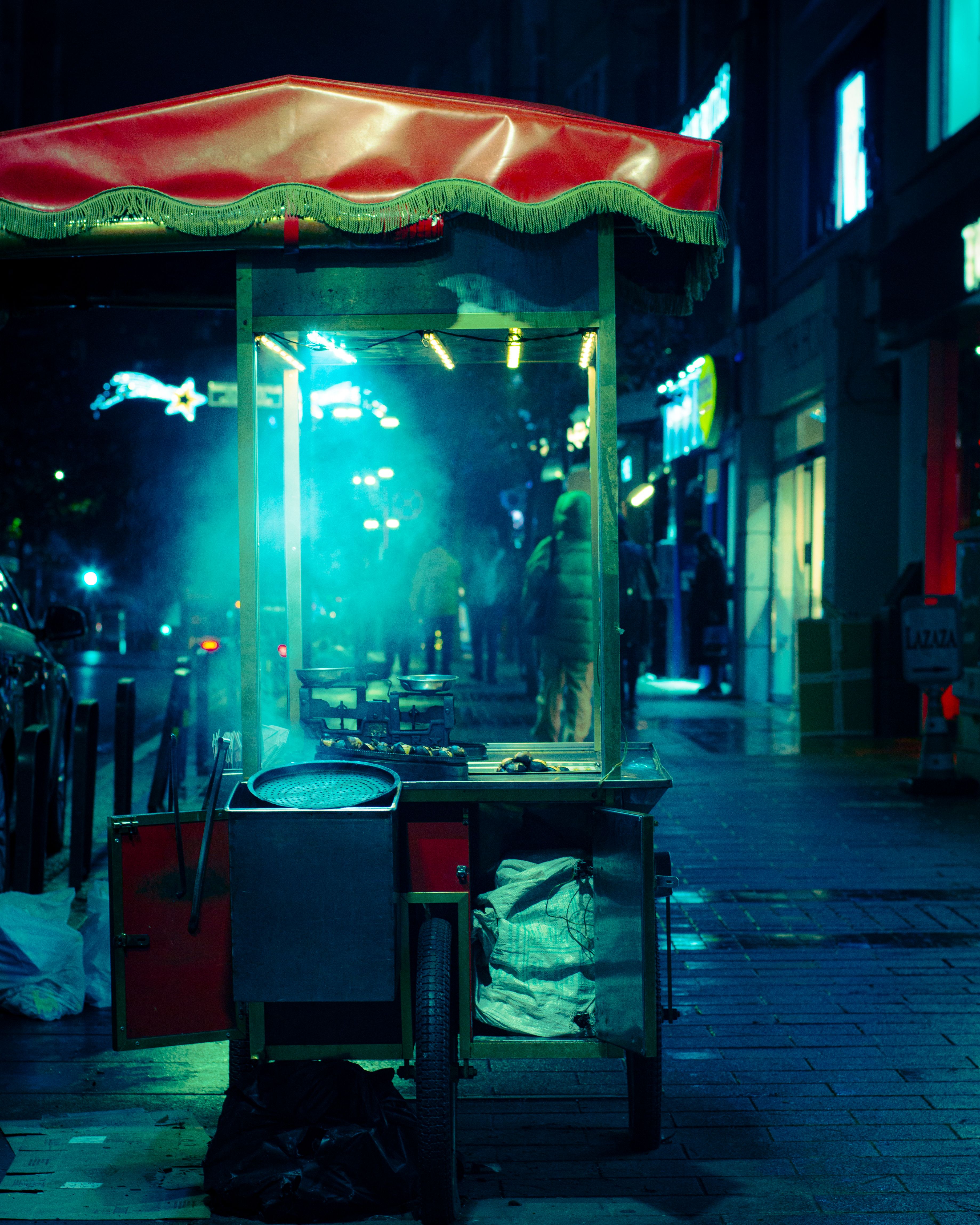 Night View of a Street Food Cart with Blue Smoke · Free Stock Photo
