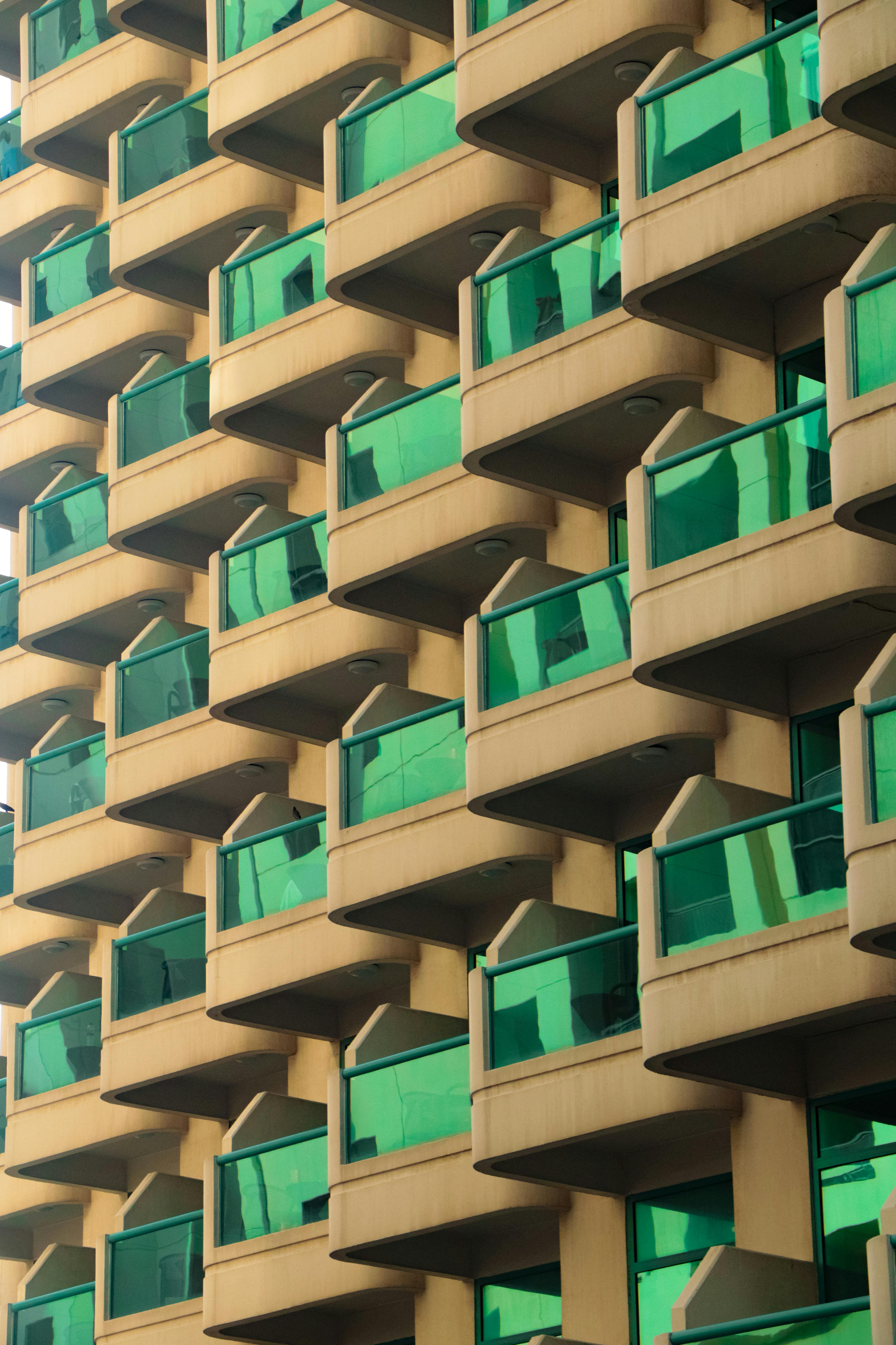 Modern Architectural Building with Green Balconies · Free Stock Photo