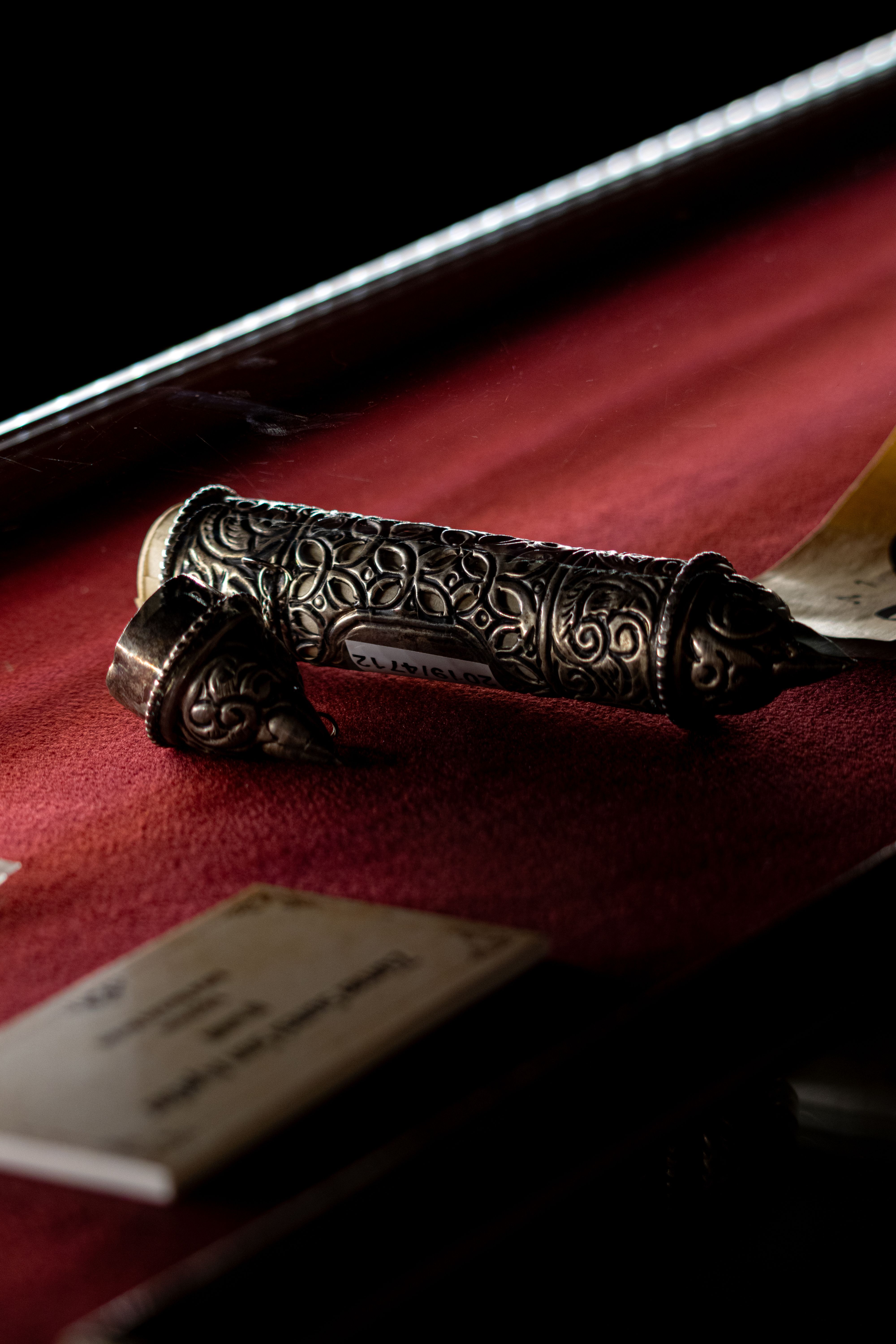 Ornate Silver Scroll Holder on Velvet Display · Free Stock Photo