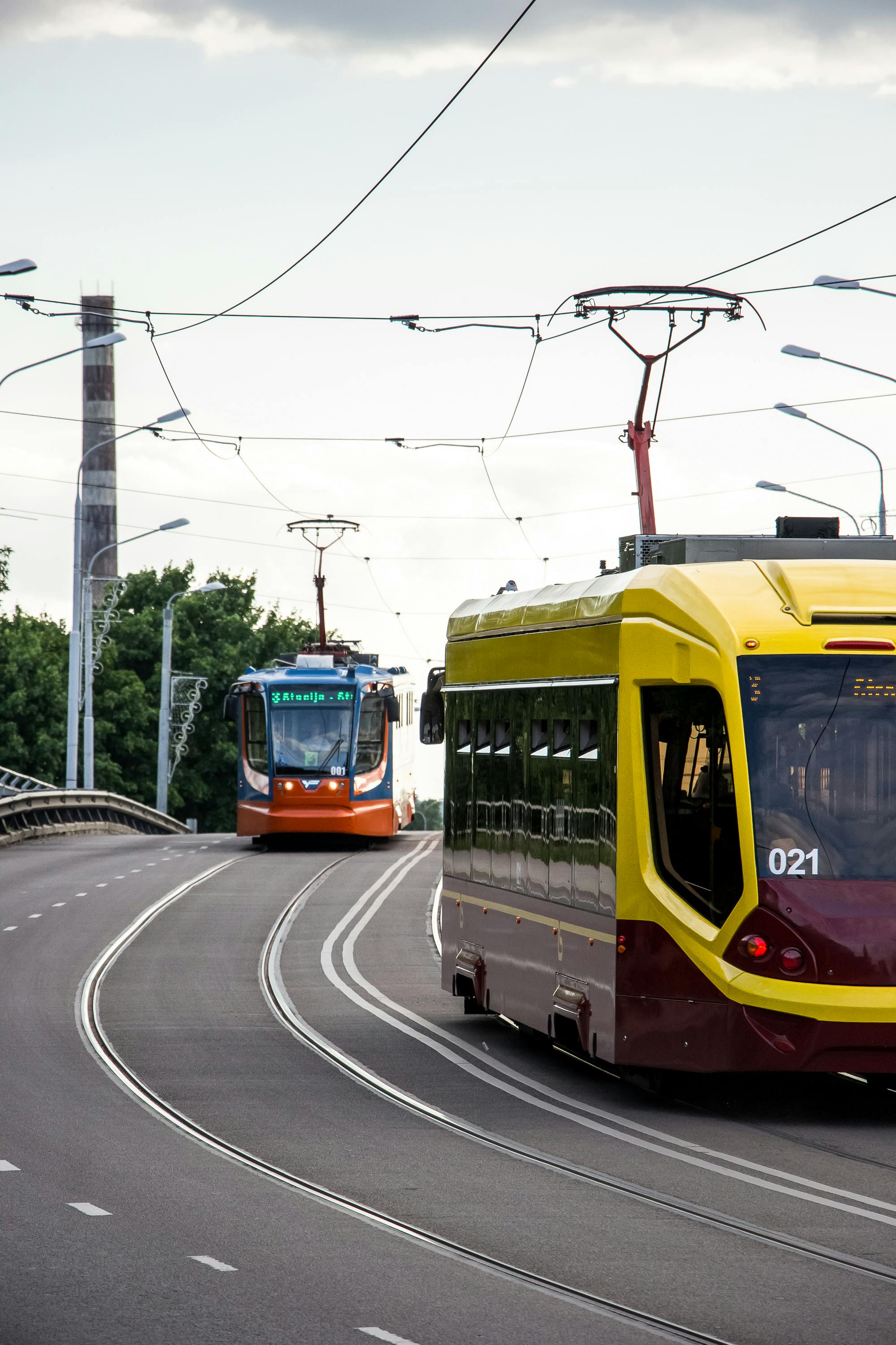 Modern Trams on Curved City Street · Free Stock Photo