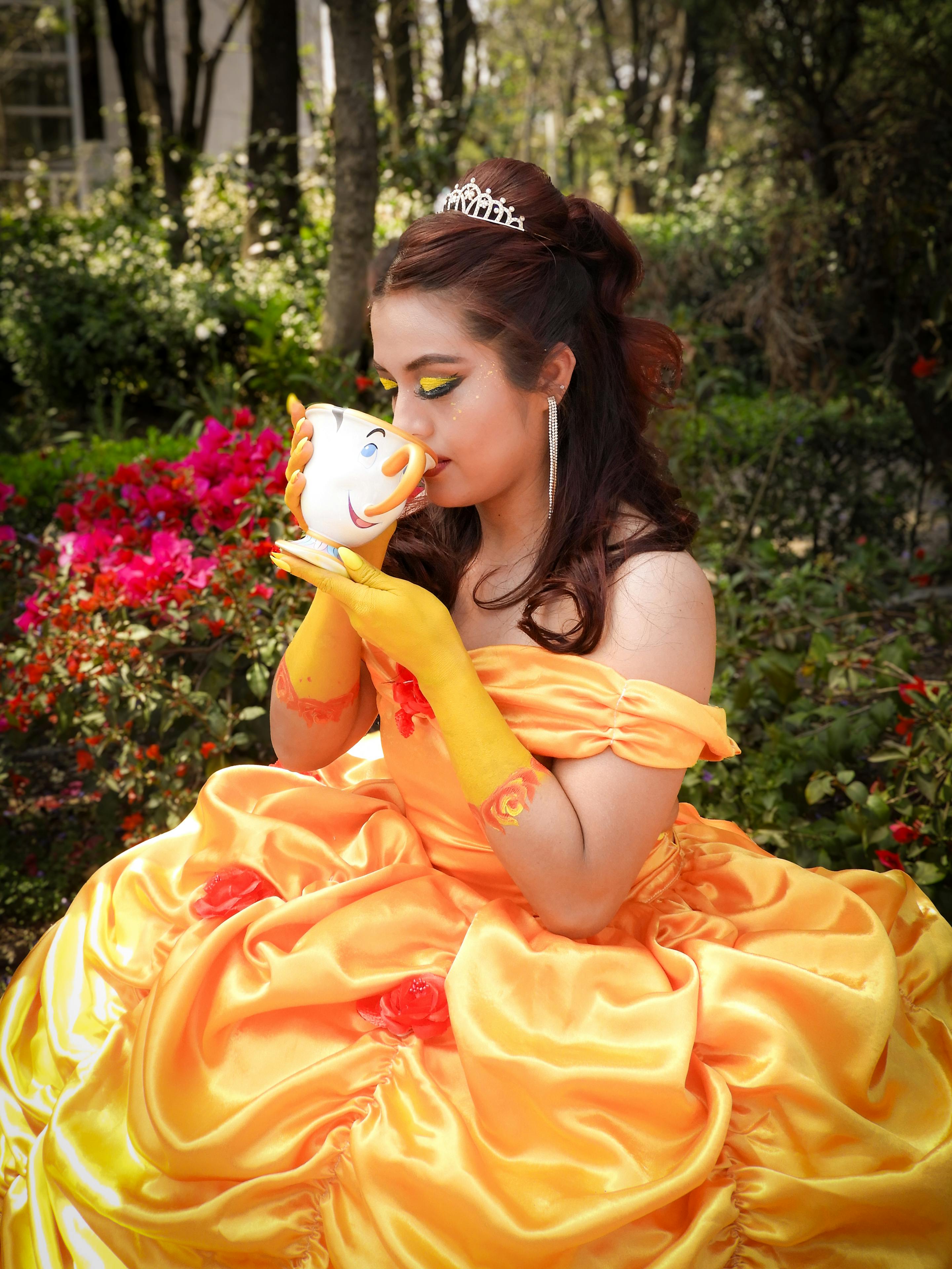 Charming Princess in Yellow Gown with Teacup · Free Stock Photo