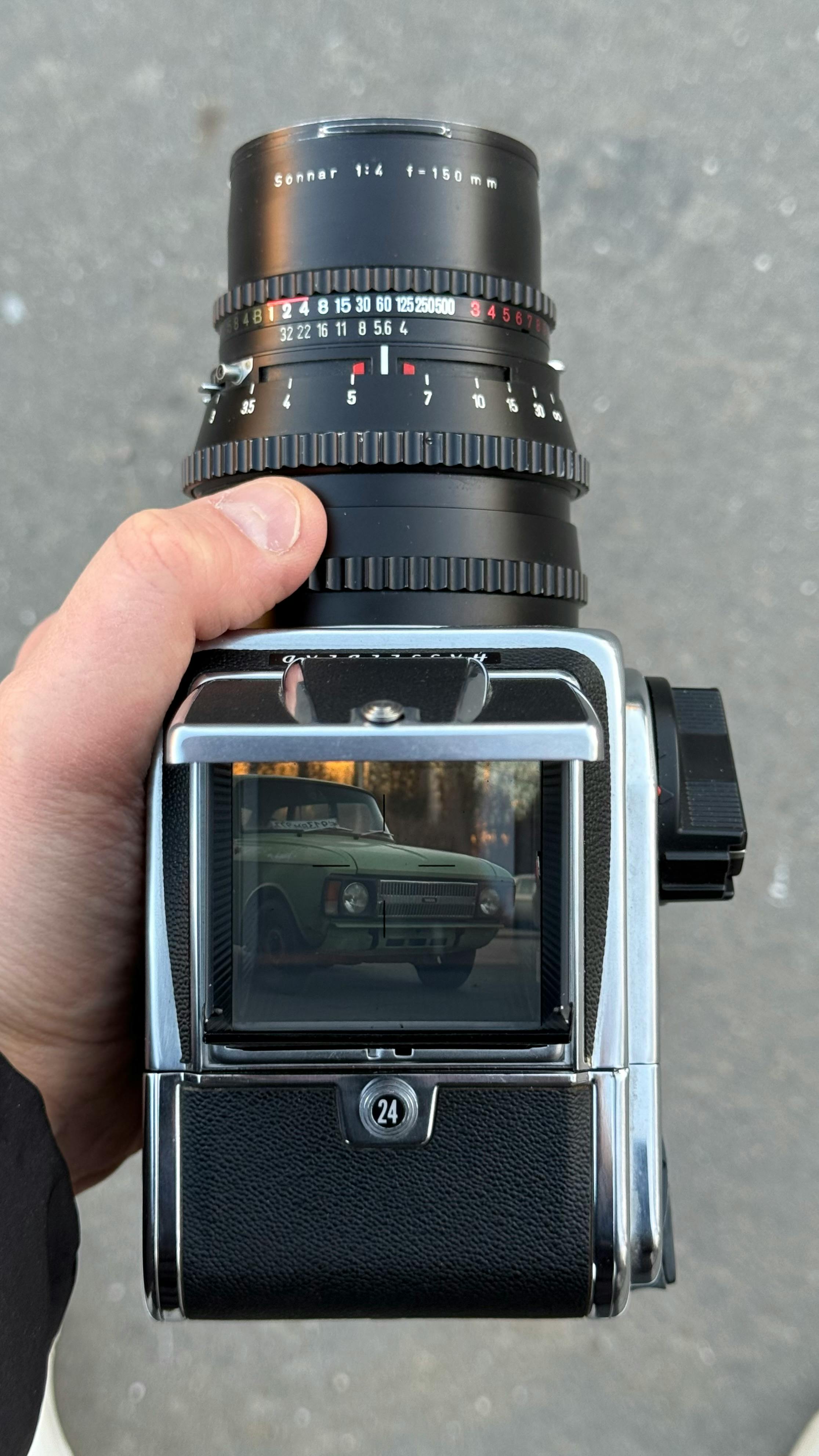 Vintage Camera with Car Reflection in Viewfinder · Free Stock Photo