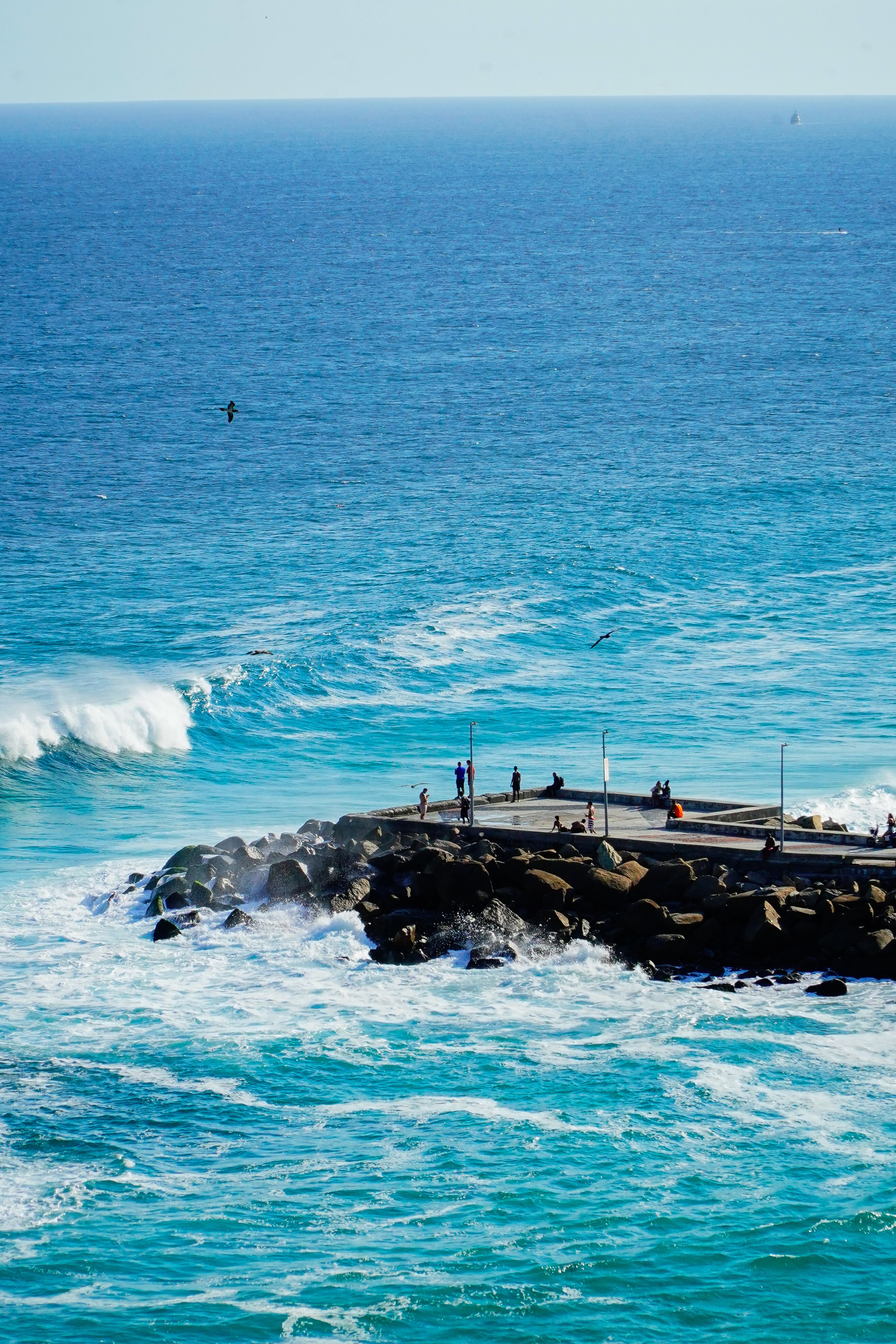 Coastal Jetty Overlooking Turquoise Ocean Waves · Free Stock Photo
