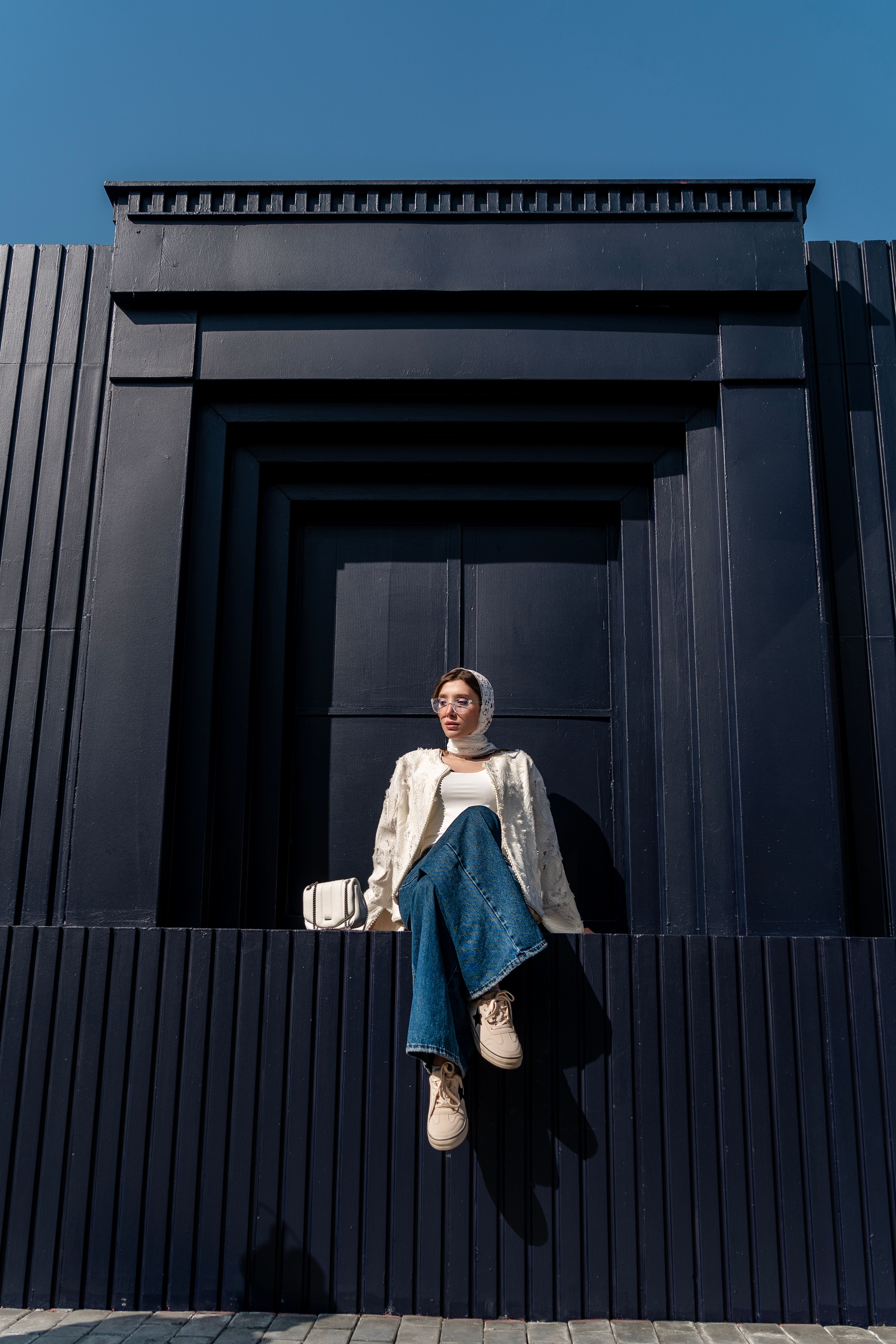 Stylish Woman Posing Against Modern Architecture · Free Stock Photo