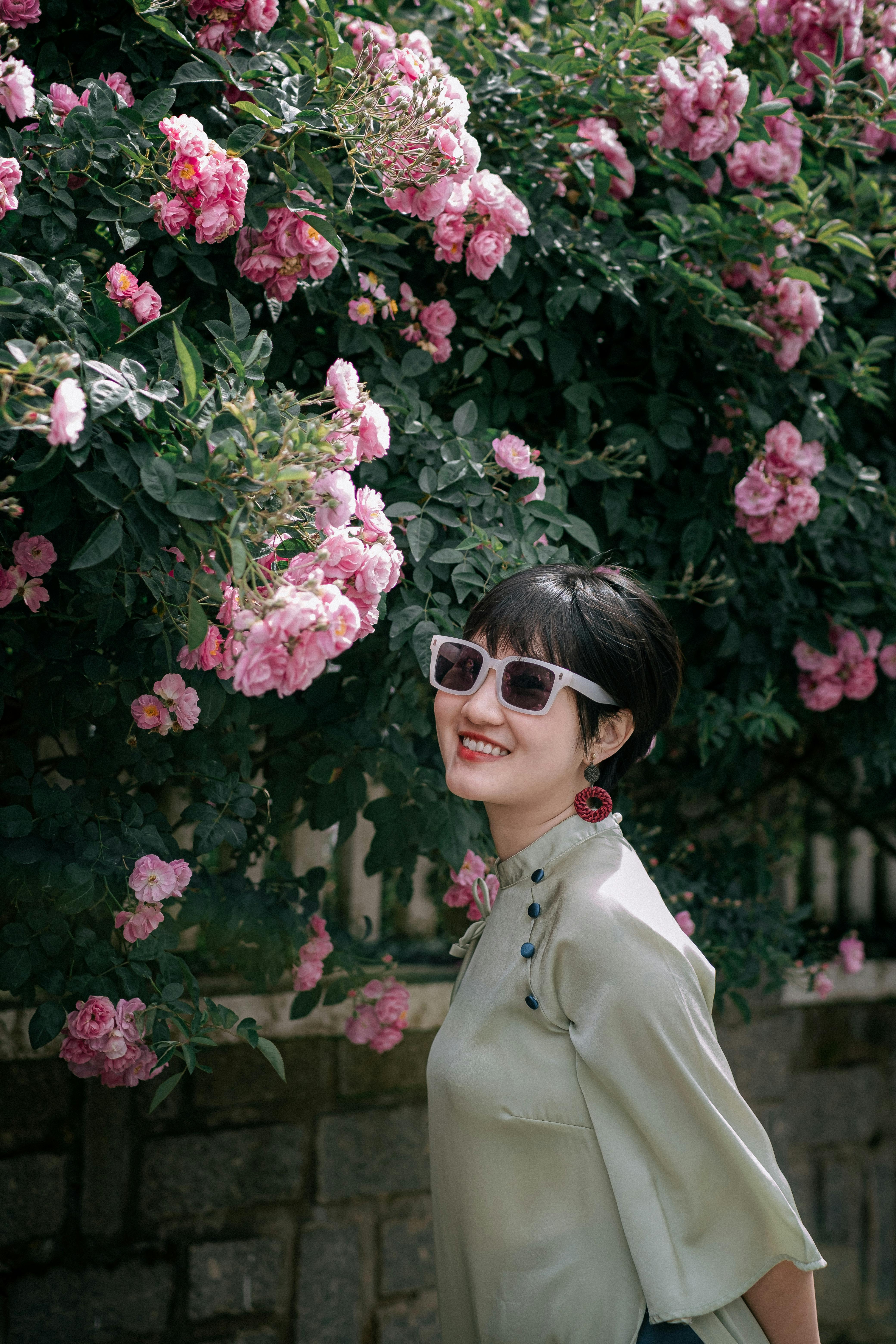 Woman Standing Against Flowers · Free Stock Photo