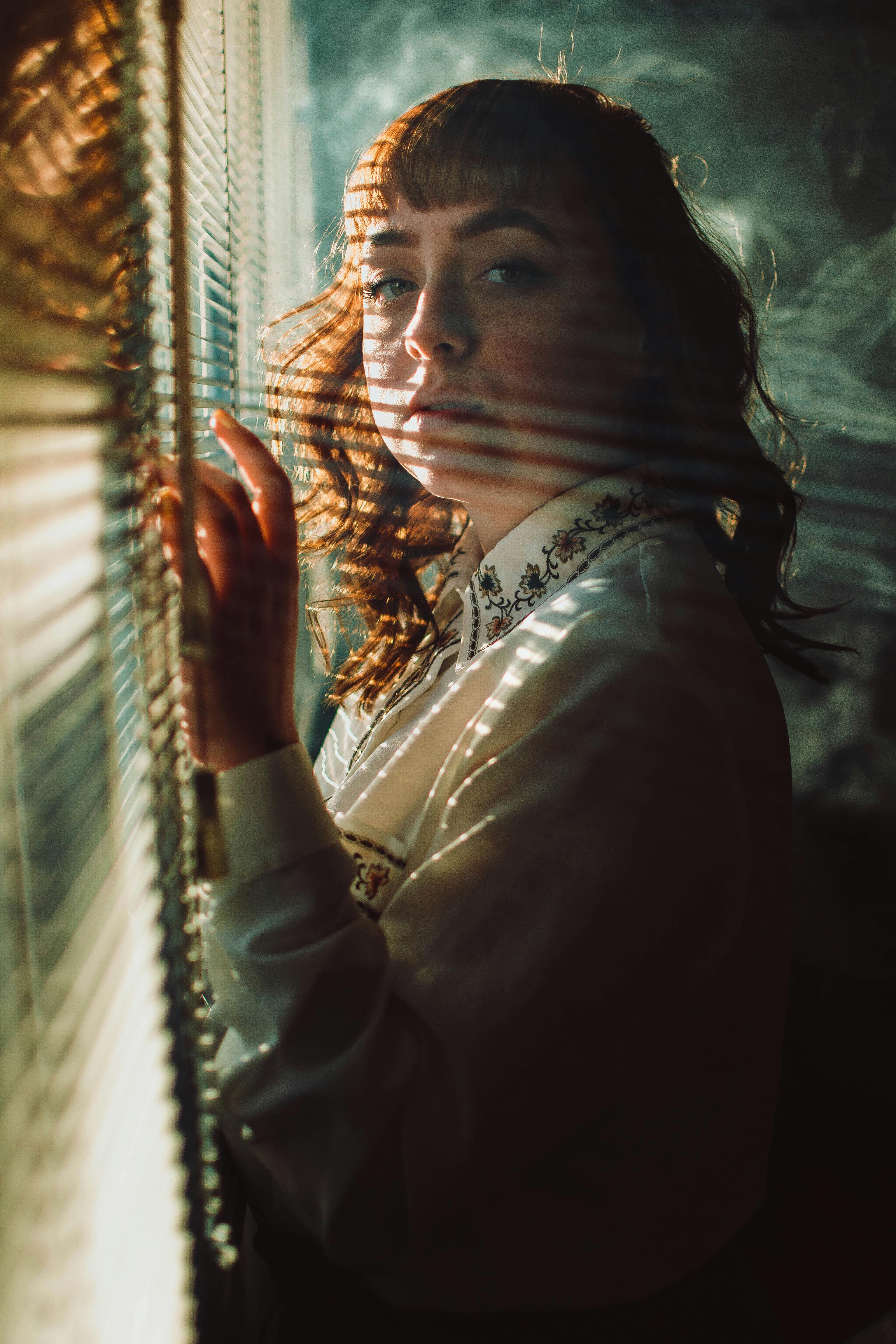 Woman Standing Beside Window · Free Stock Photo