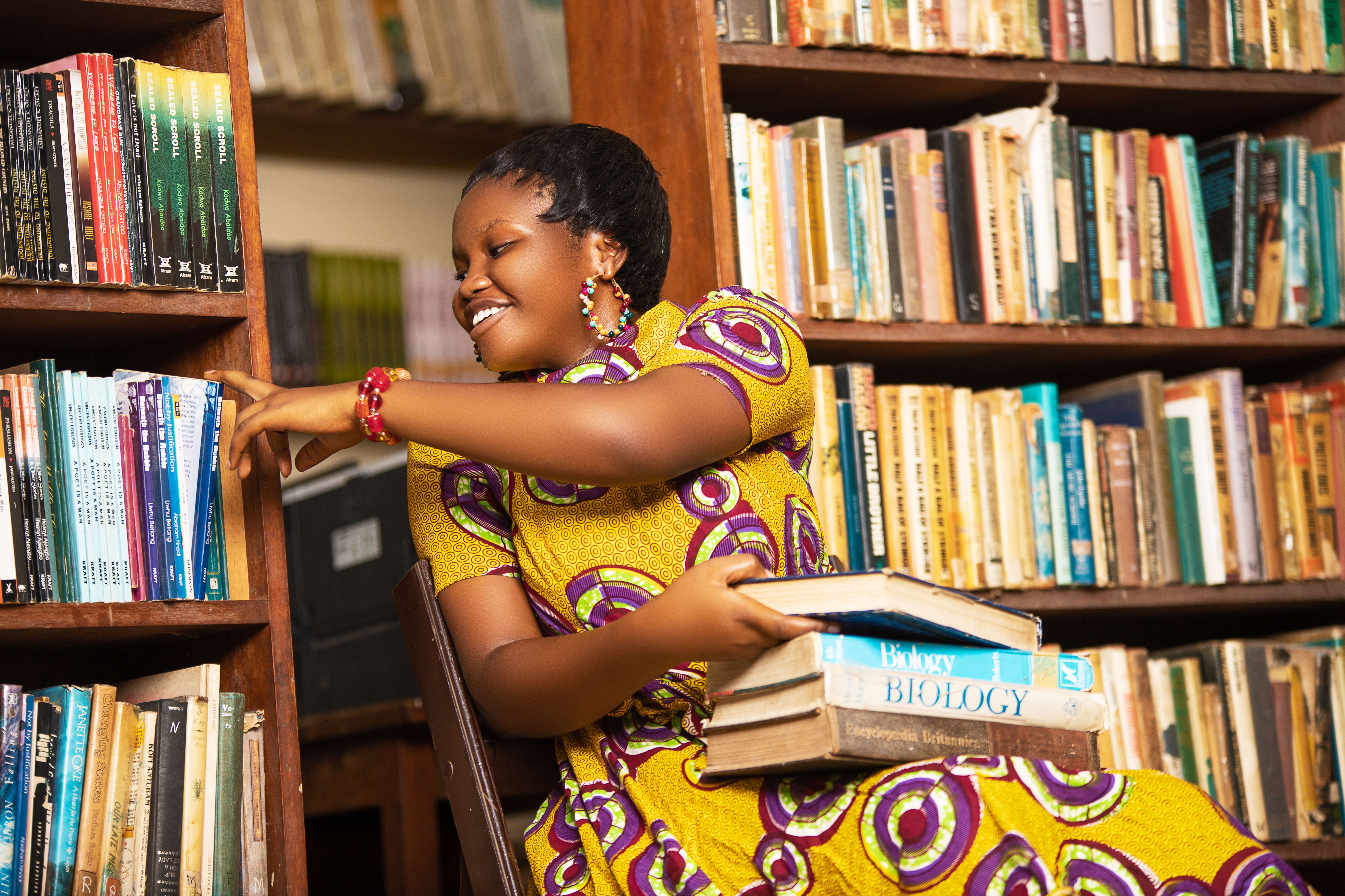 African Woman Reading Books in Ghana Library · Free Stock Photo