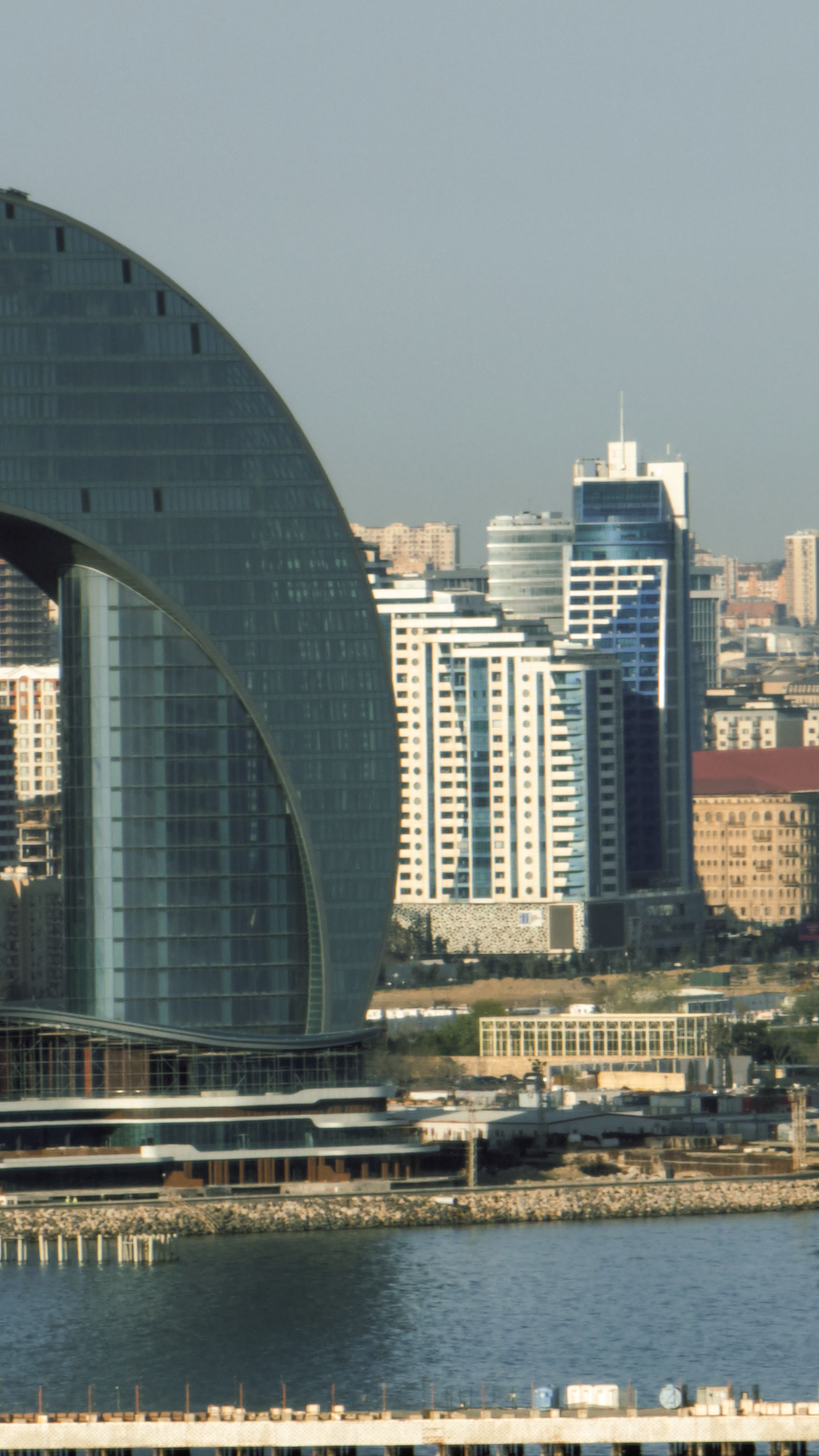 Modern Skyline with Iconic Crescent Building · Free Stock Photo