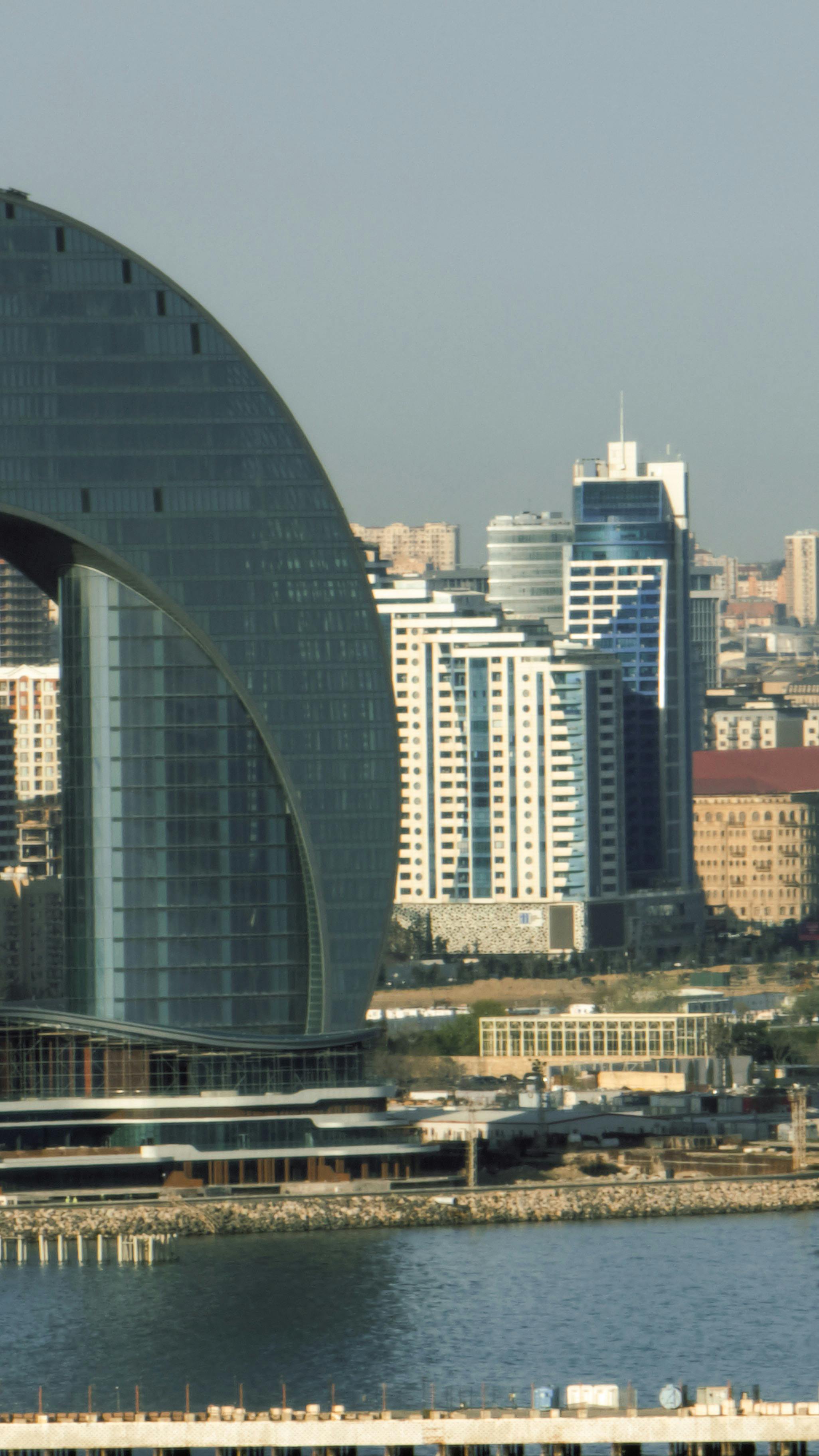 Modern Skyline with Iconic Crescent Building · Free Stock Photo