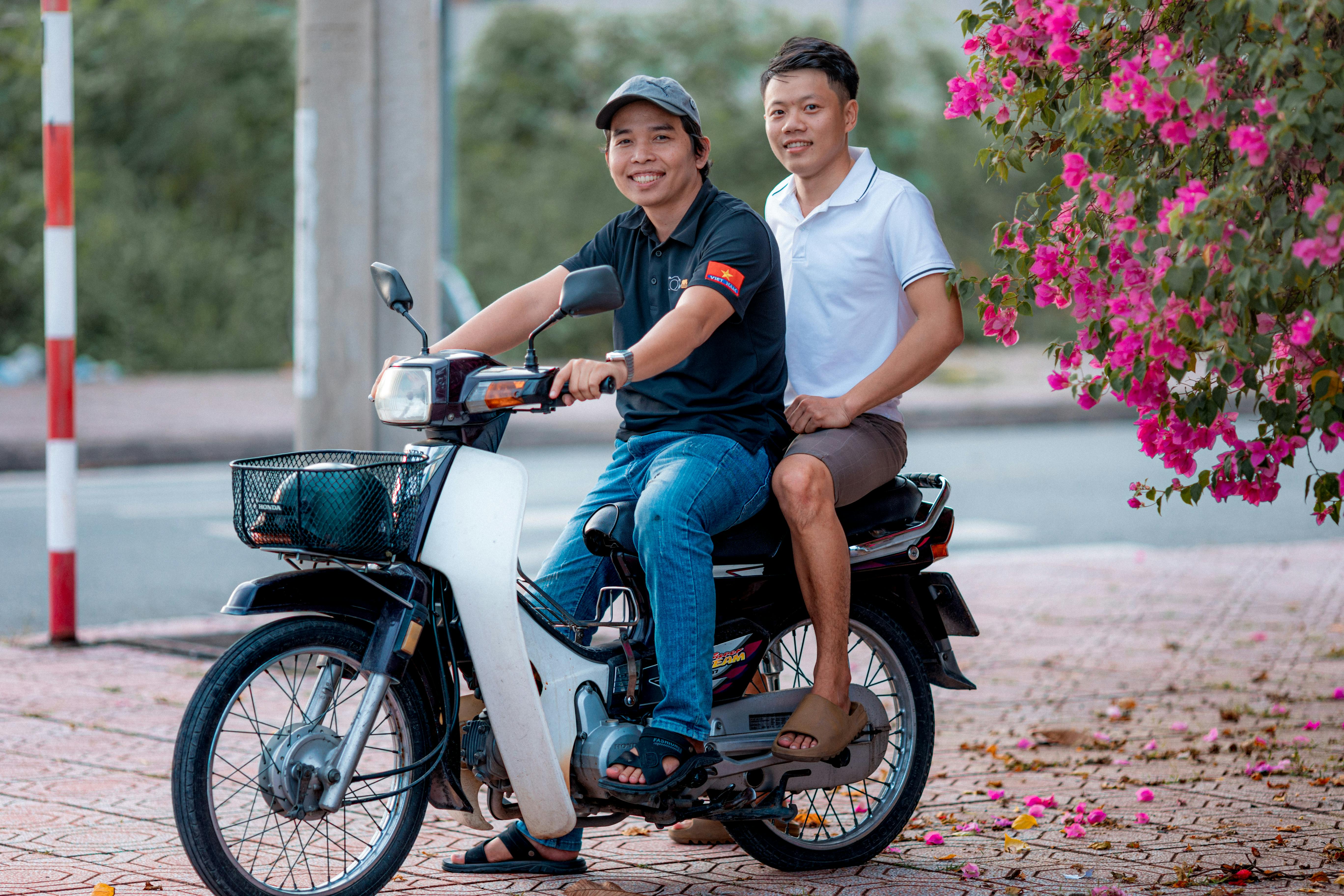 Two Friends Riding a Motorcycle in Vietnam · Free Stock Photo