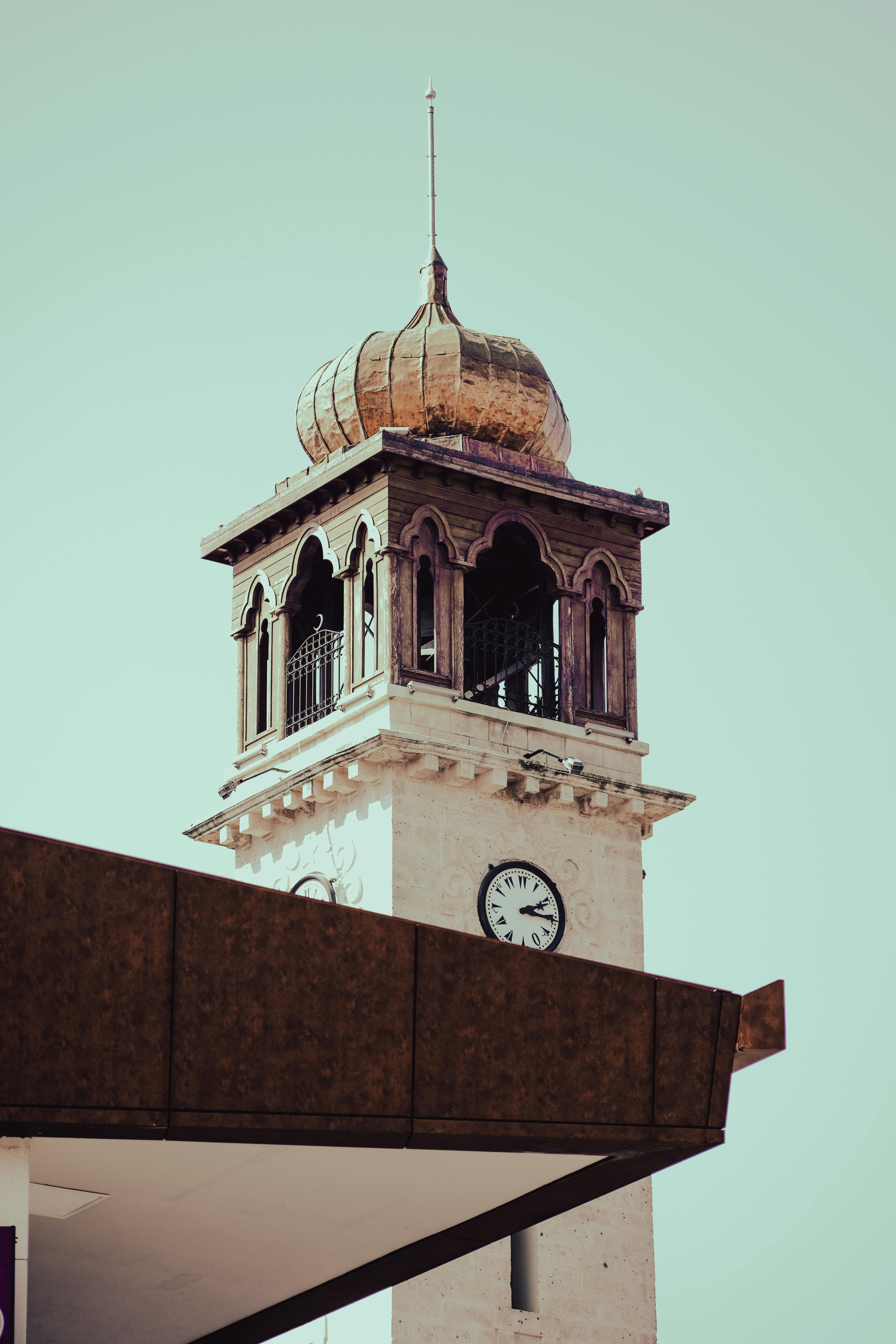 Historic Clock Tower with Dome Against Blue Sky · Free Stock Photo