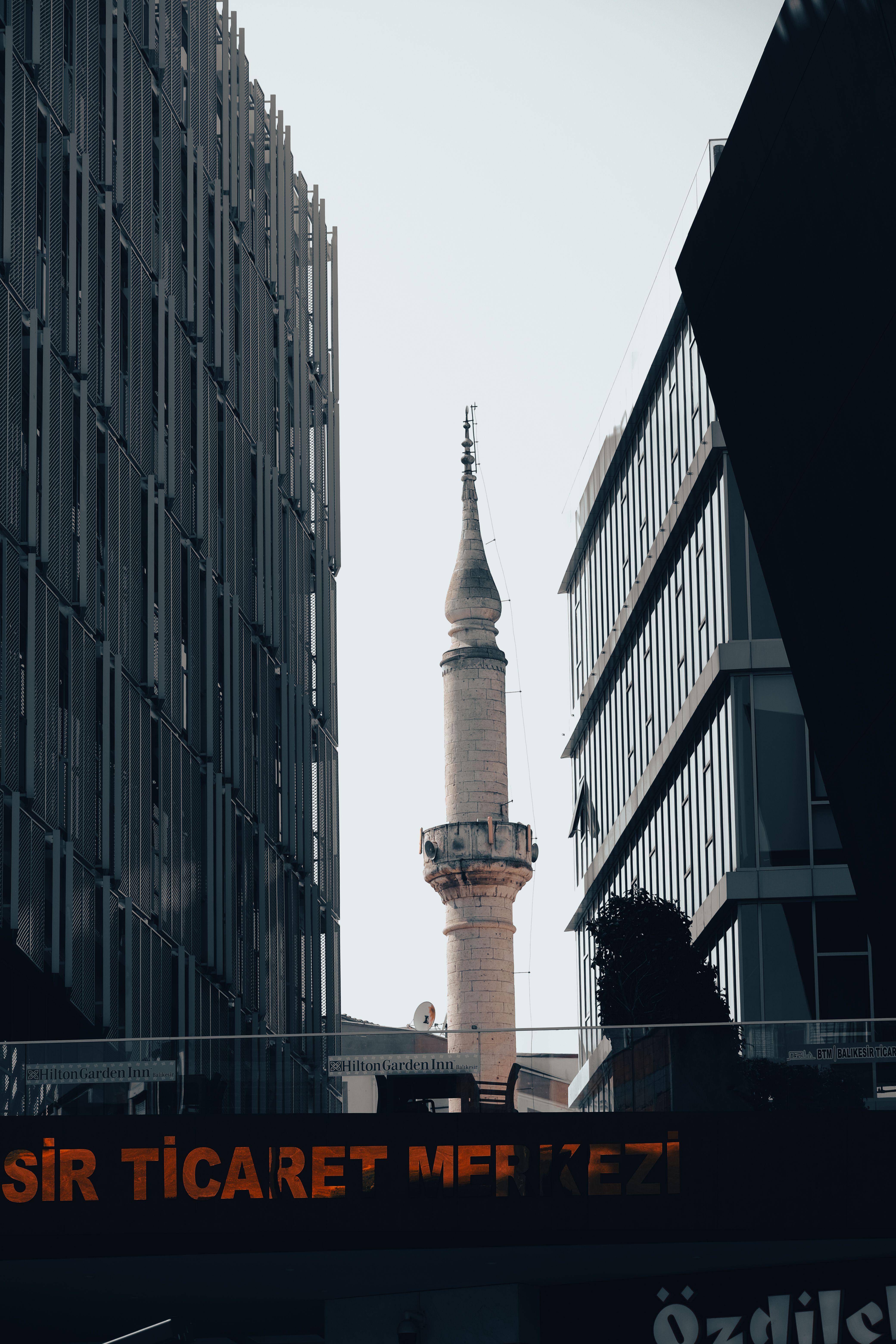 Modern cityscape with mosque minaret · Free Stock Photo
