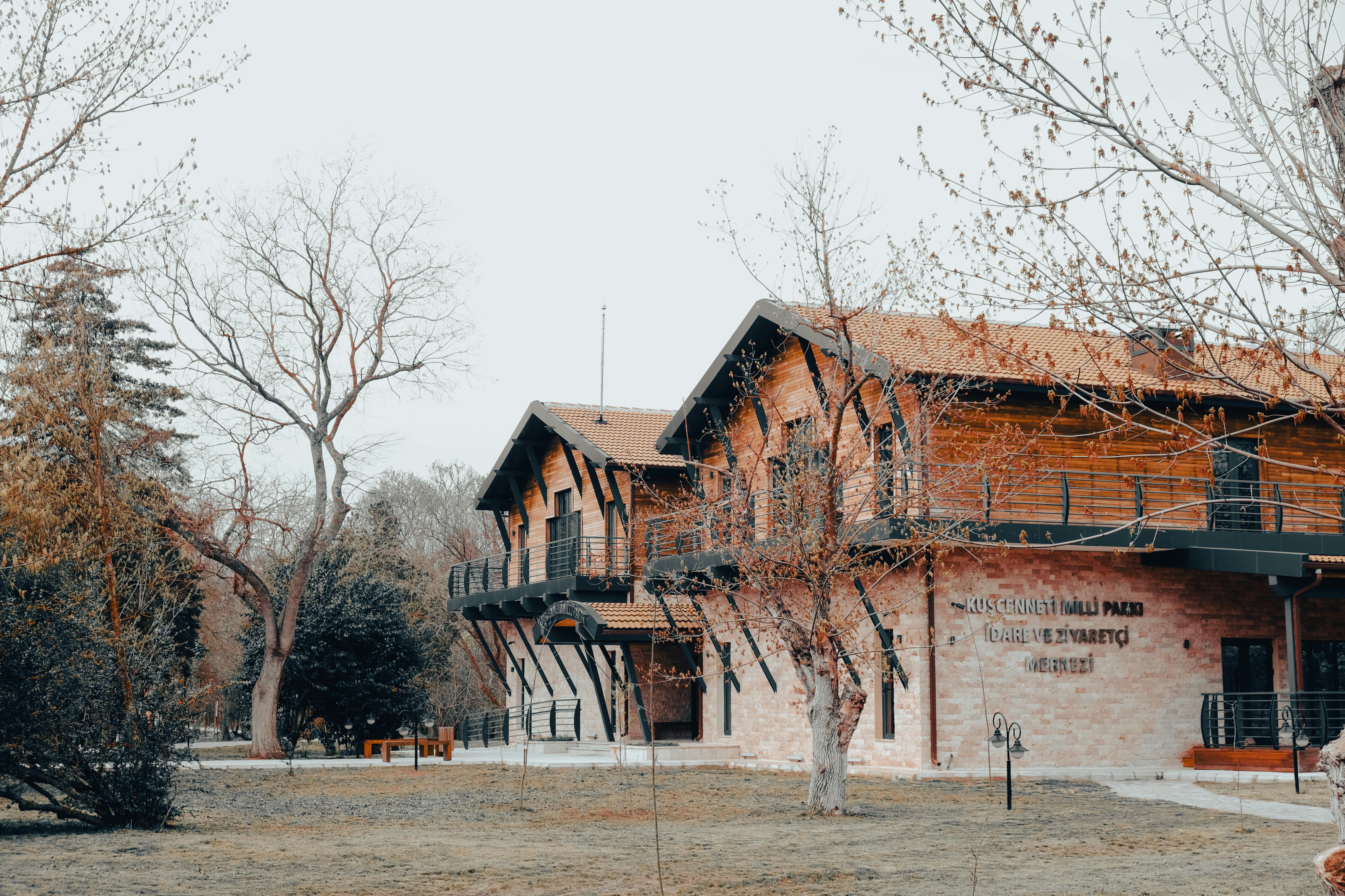 Rustic Wooden Building Surrounded by Trees in Park · Free Stock Photo