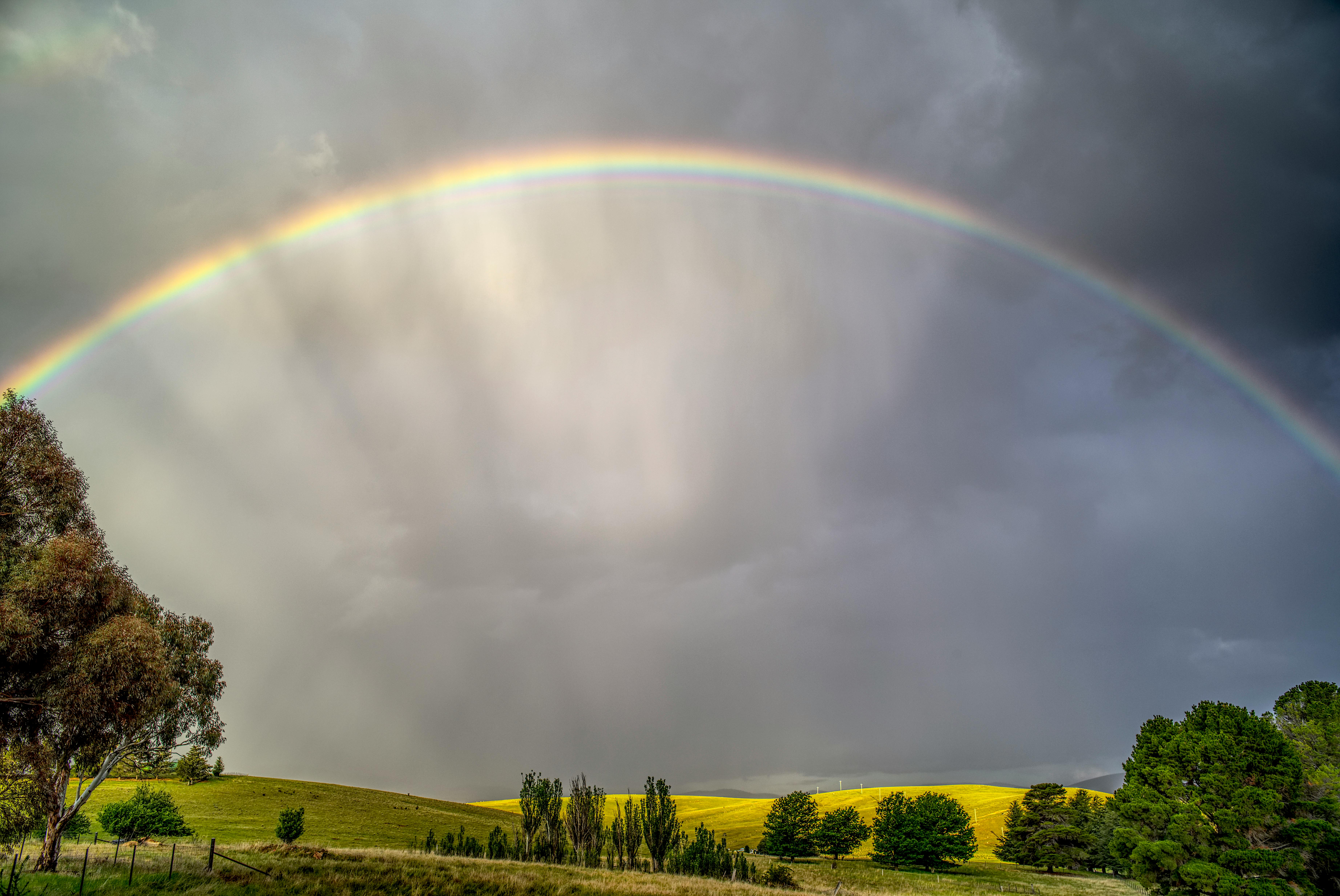 Breathtaking Rainbow Over Lush Green Landscape · Free Stock Photo