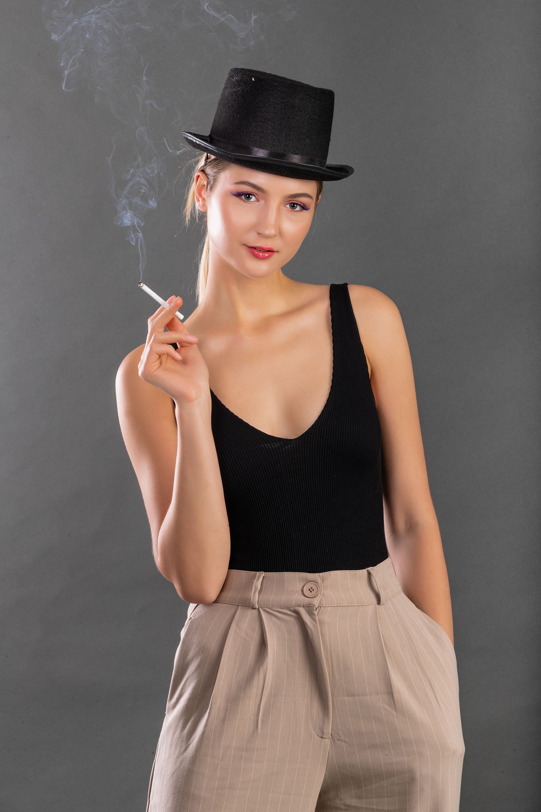 Stylish Woman Posing with Cigarette in Studio · Free Stock Photo